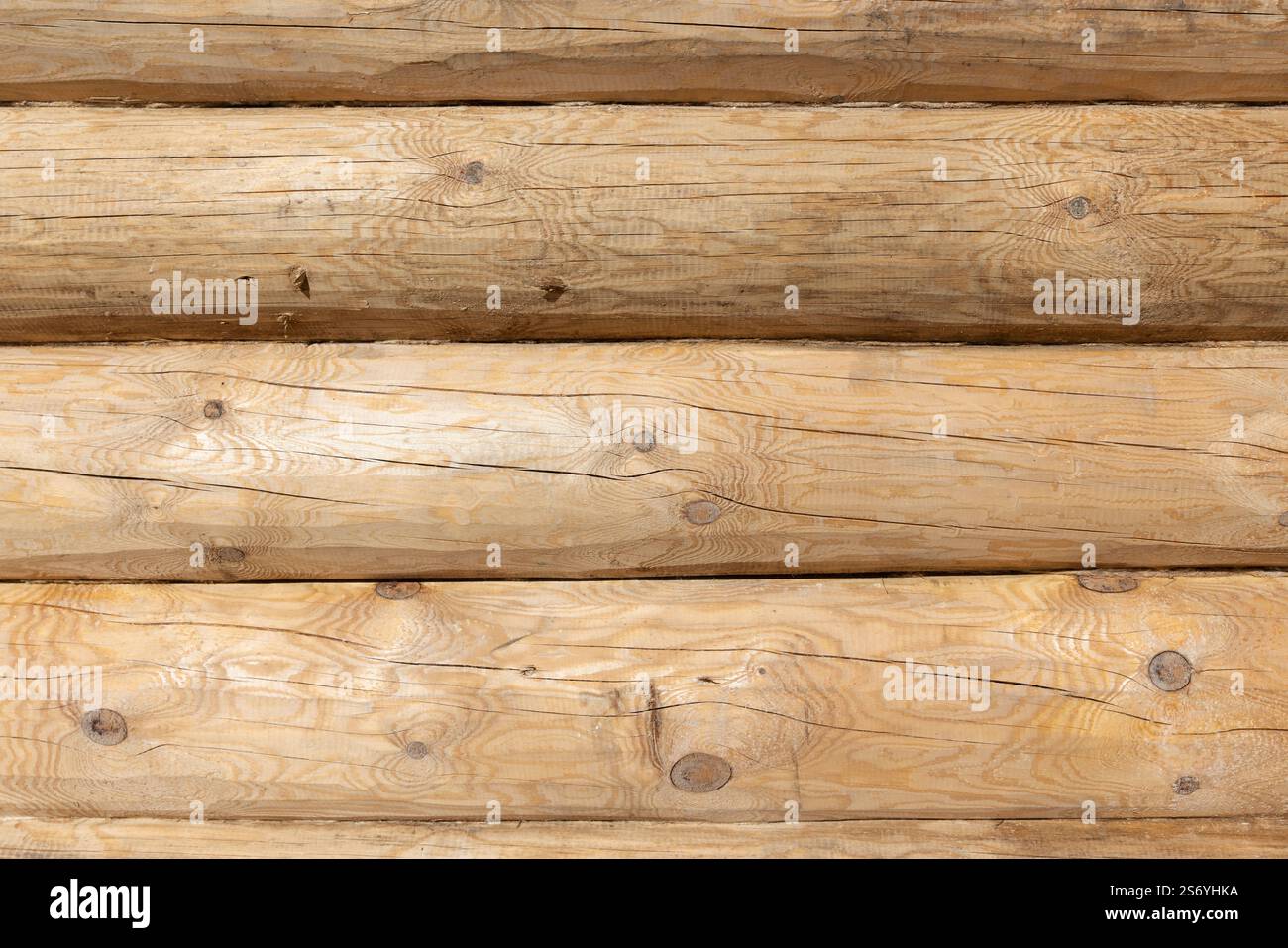 New wooden wall made of uncolored natural pine tree logs, front view ...