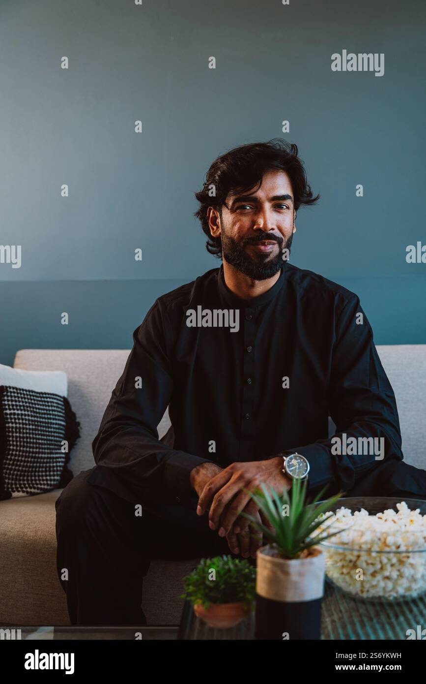 Indian man eating popcorn watching hi-res stock photography and images ...