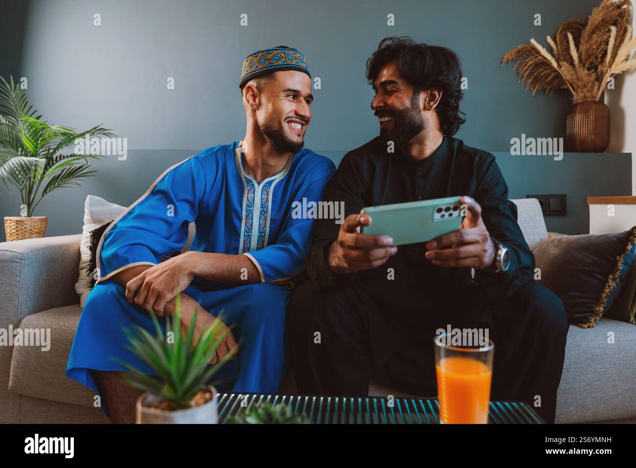 Friends watching funny memes on the smartphone and having fun laughing ...