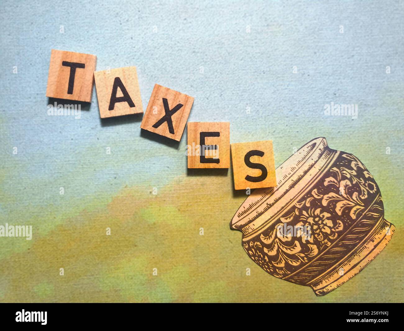 Conceptual collage art of wooden letters forming the word „taxes“ and a ...