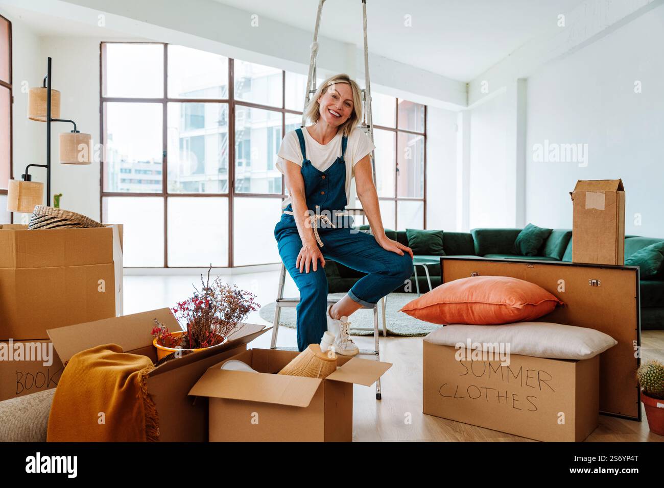 Single woman relocating in a new apartment. Middle aged senior ...