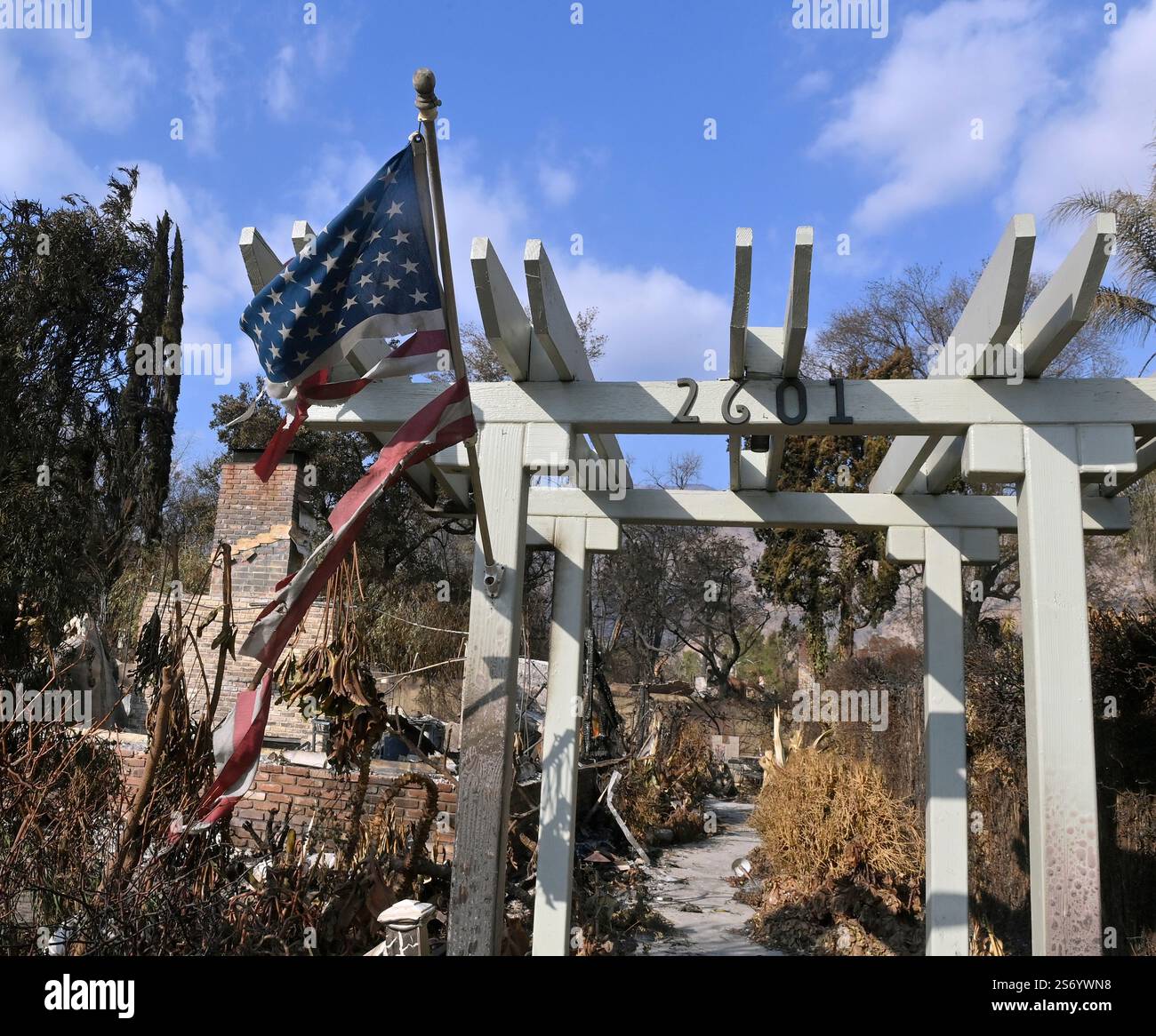 A chimney and a tattered American flag is all that remains of a house ...