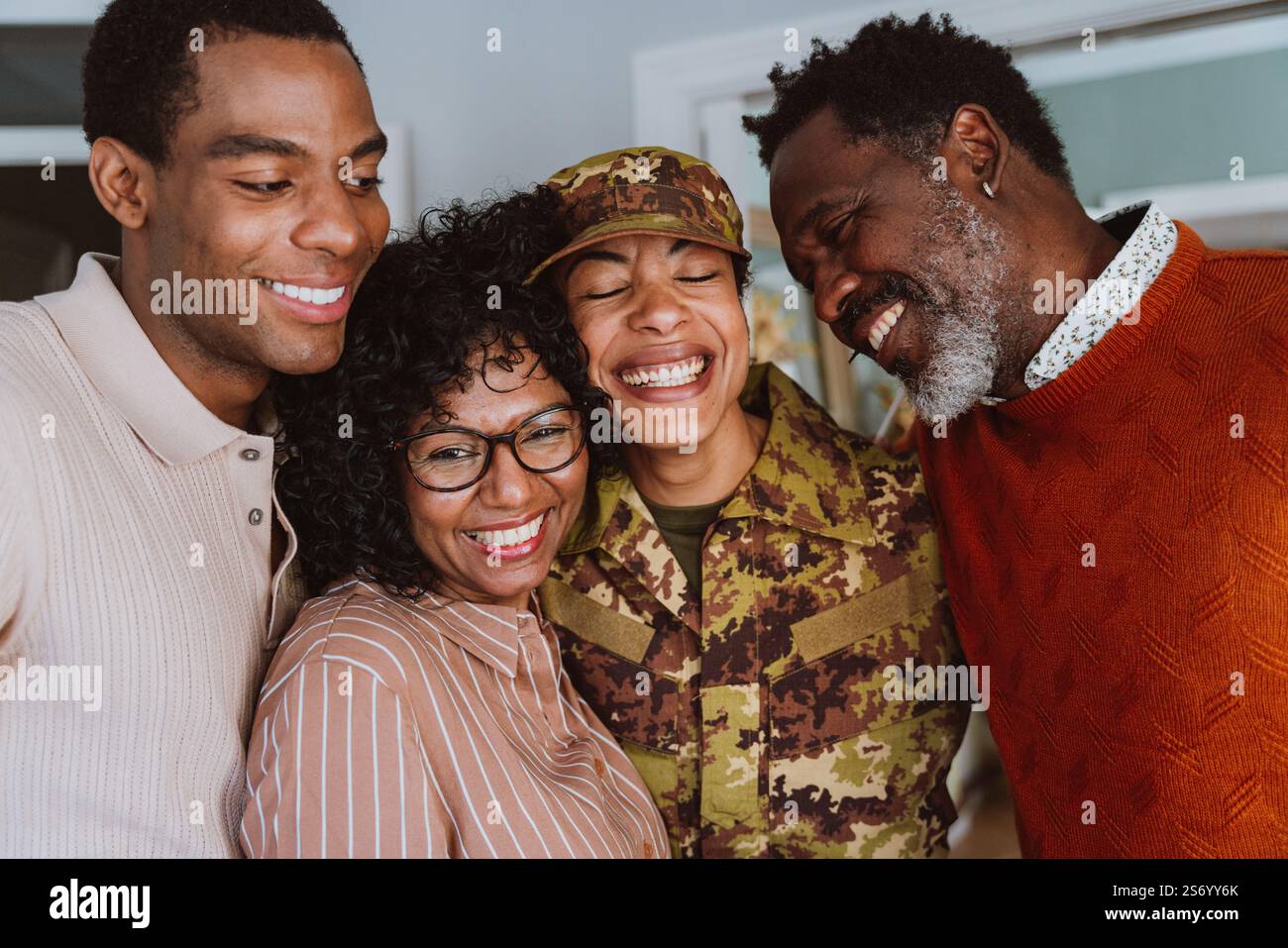 Us Veteran woman homecoming. Young woman coming back to her family from ...