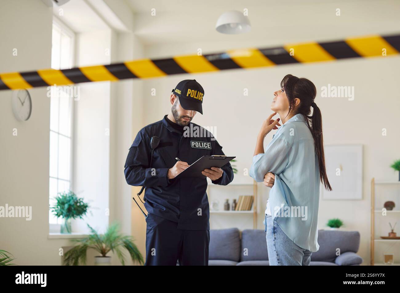 Policeman, female witness interviewing, crime danger scene barricade ...