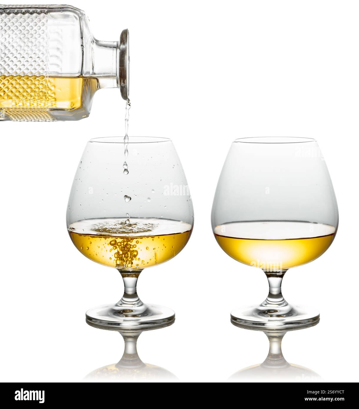 Cognac pouring into a snifter. Isolated on a white background Stock ...