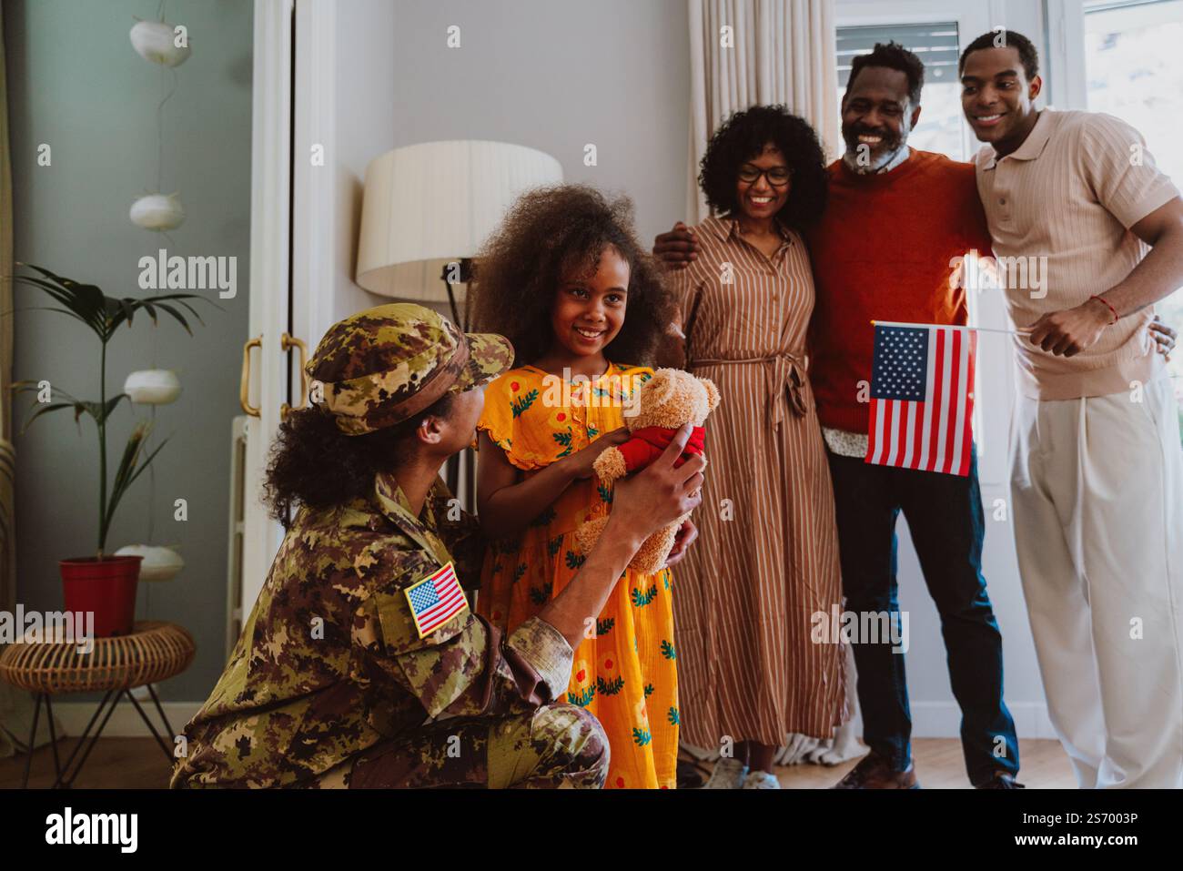 Us Veteran woman homecoming. Young woman coming back to her family from ...