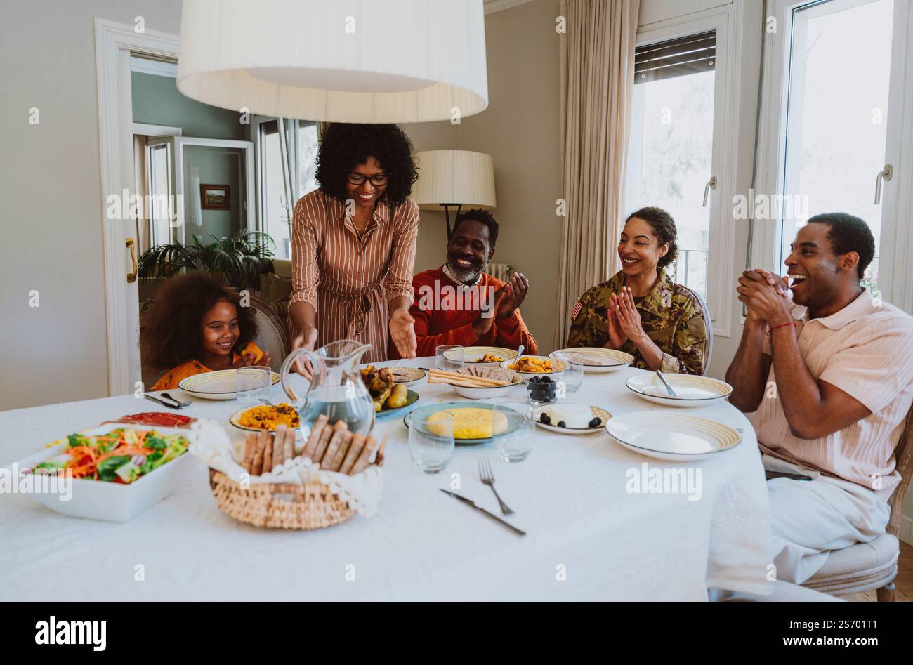 Us Veteran woman homecoming. Young woman coming back to her family from ...