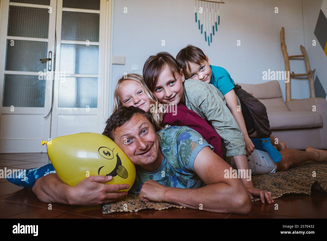 Happy father with three children Stock Photo - Alamy