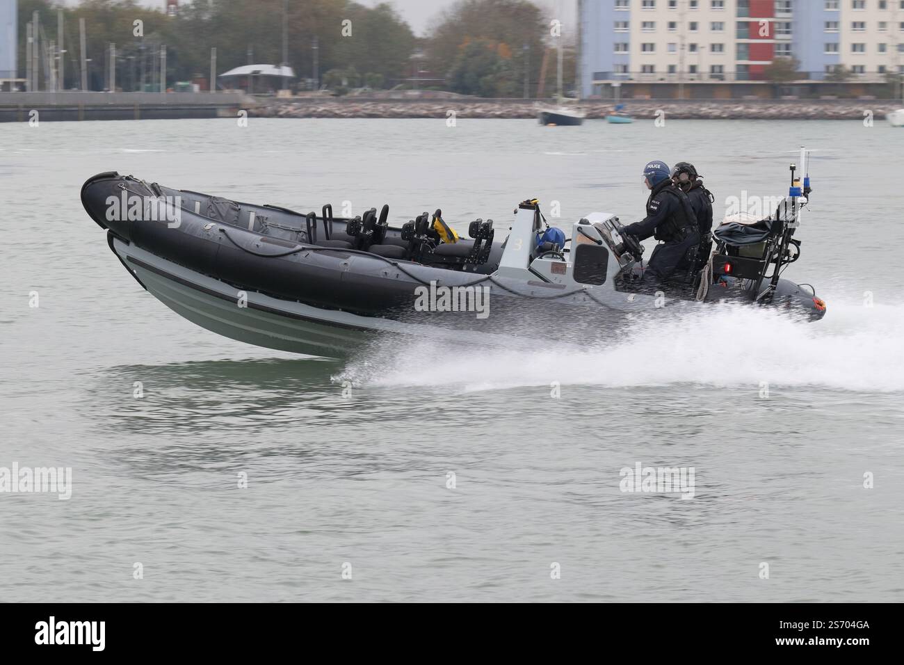 A Ministry of Defence police rigid hulled inflatable patrol boat speeds ...