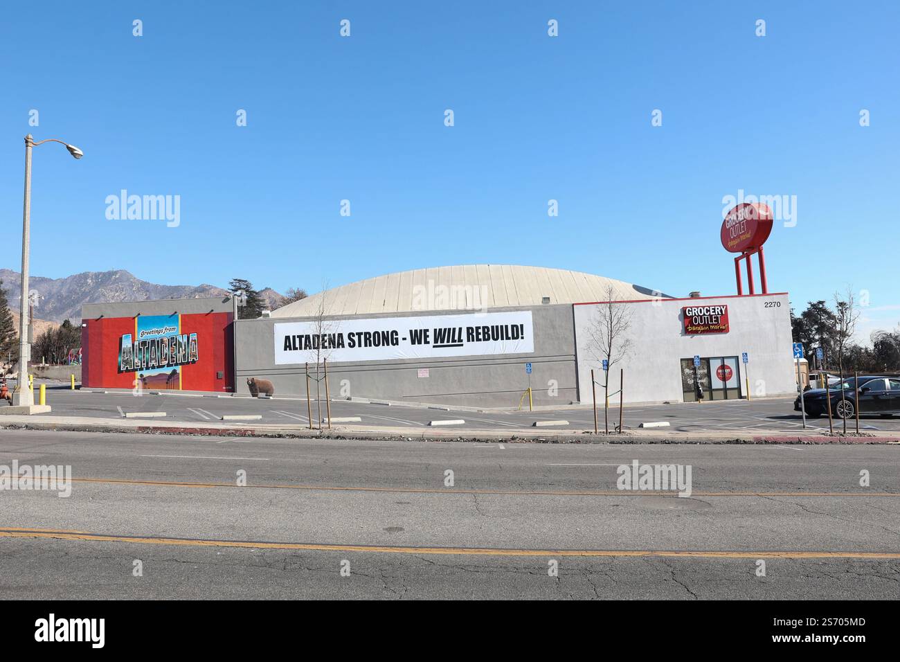 A supermarket with a banner “Altadena strong, we will rebuilt ...