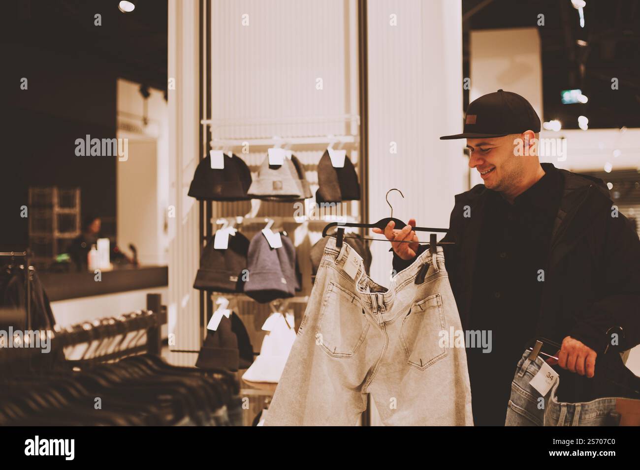 man in clothing store Stock Photo - Alamy