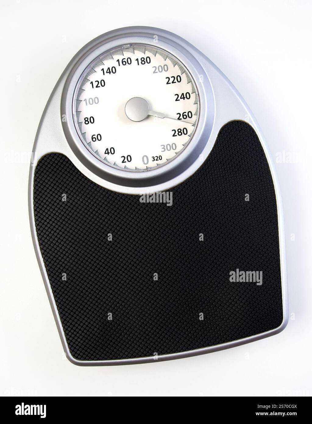 A traditional analog weight scale with a black surface and a white dial ...