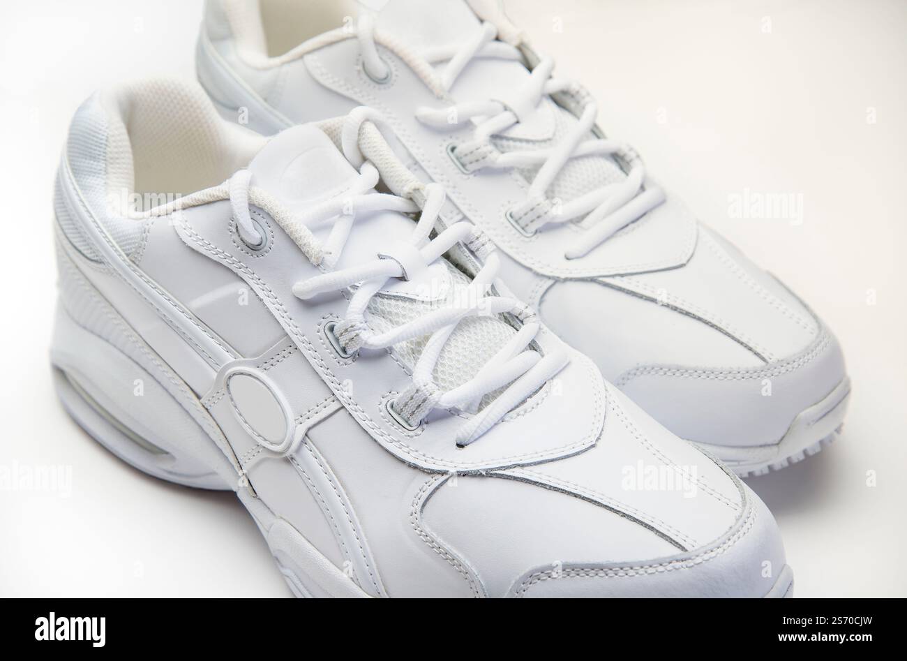 White gym shoes showing detailed design and texture on a clean studio ...