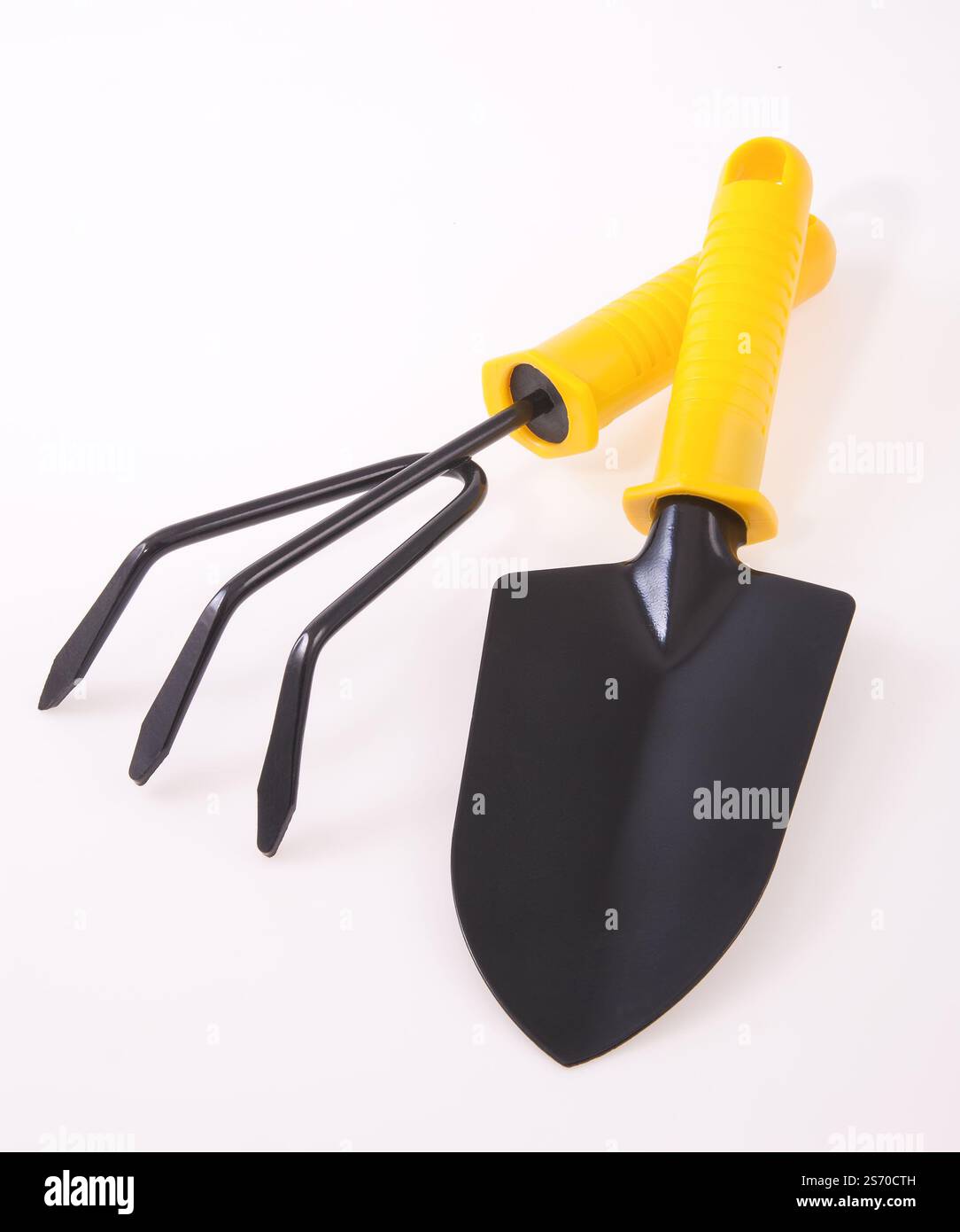 Horizontal close-up image of gardening equipment including a trowel and ...