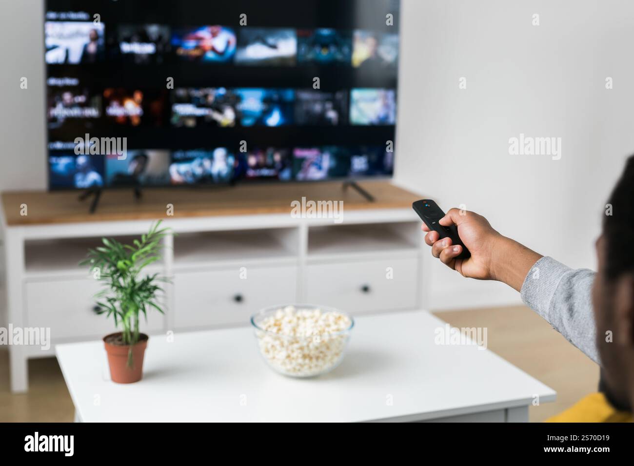 Remote control is pointed toward the television screen, control and ...