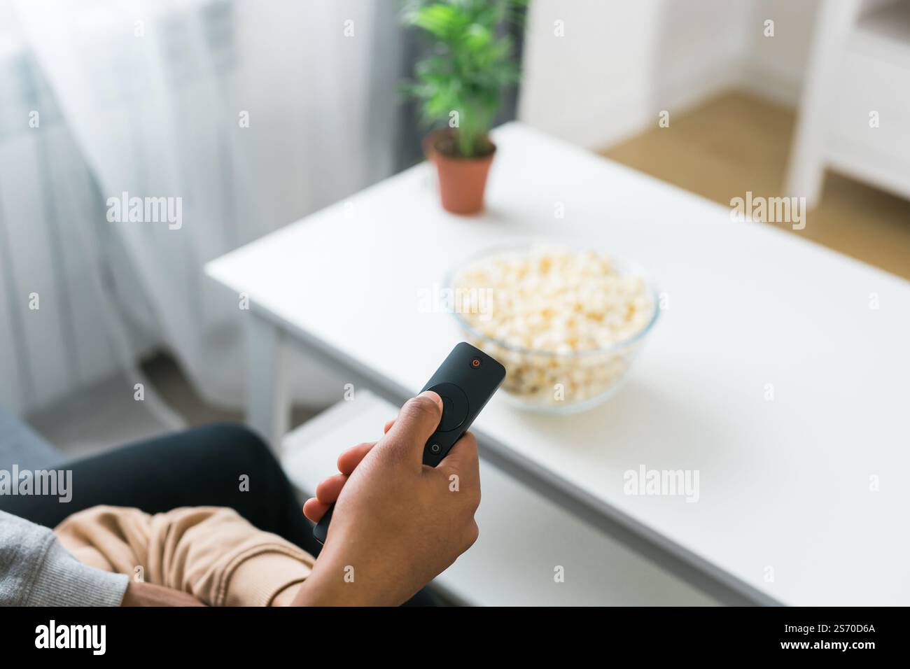 Remote control is pointed toward the television screen, control and ...