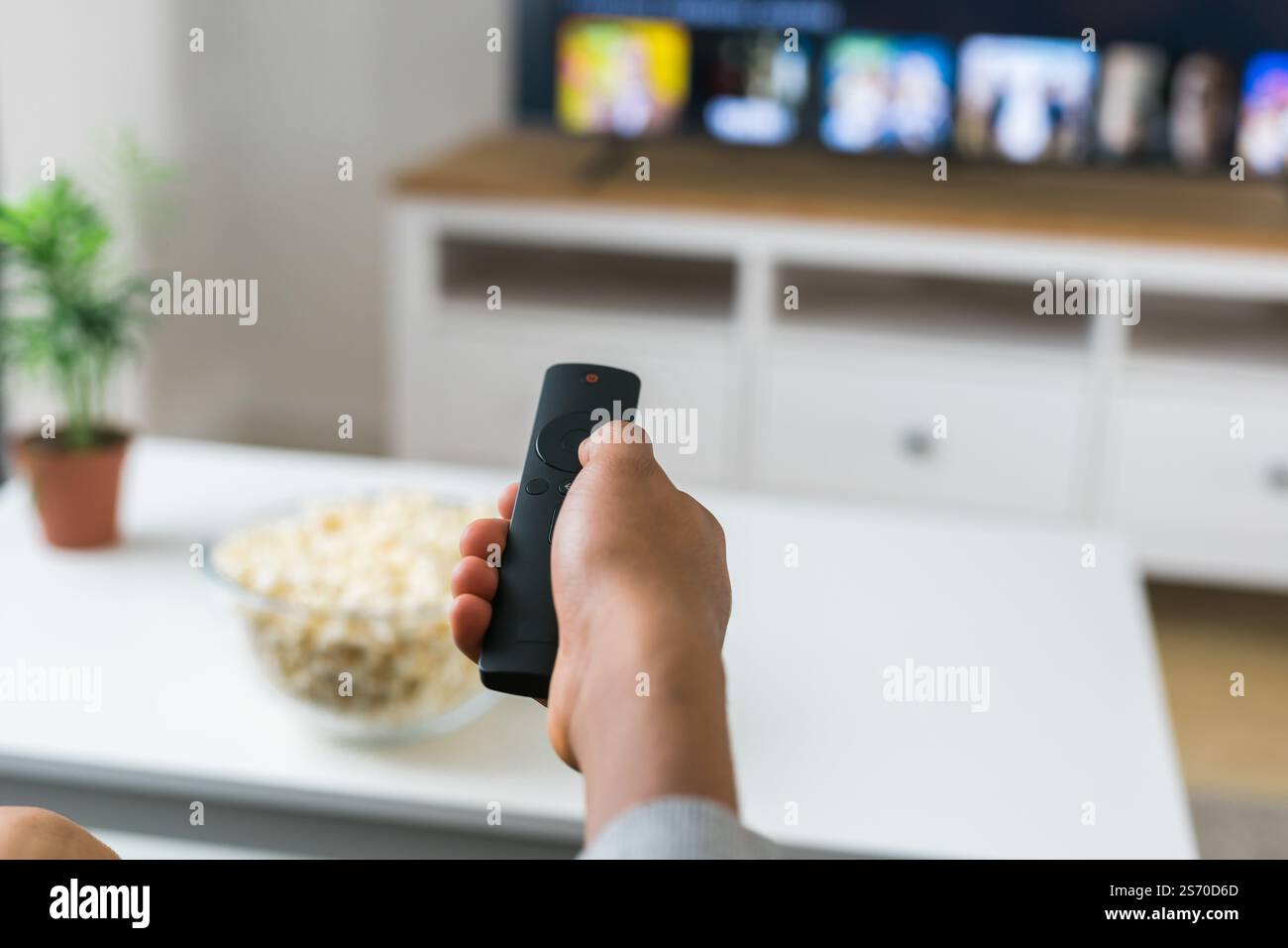 Remote control is pointed toward the television screen, control and ...
