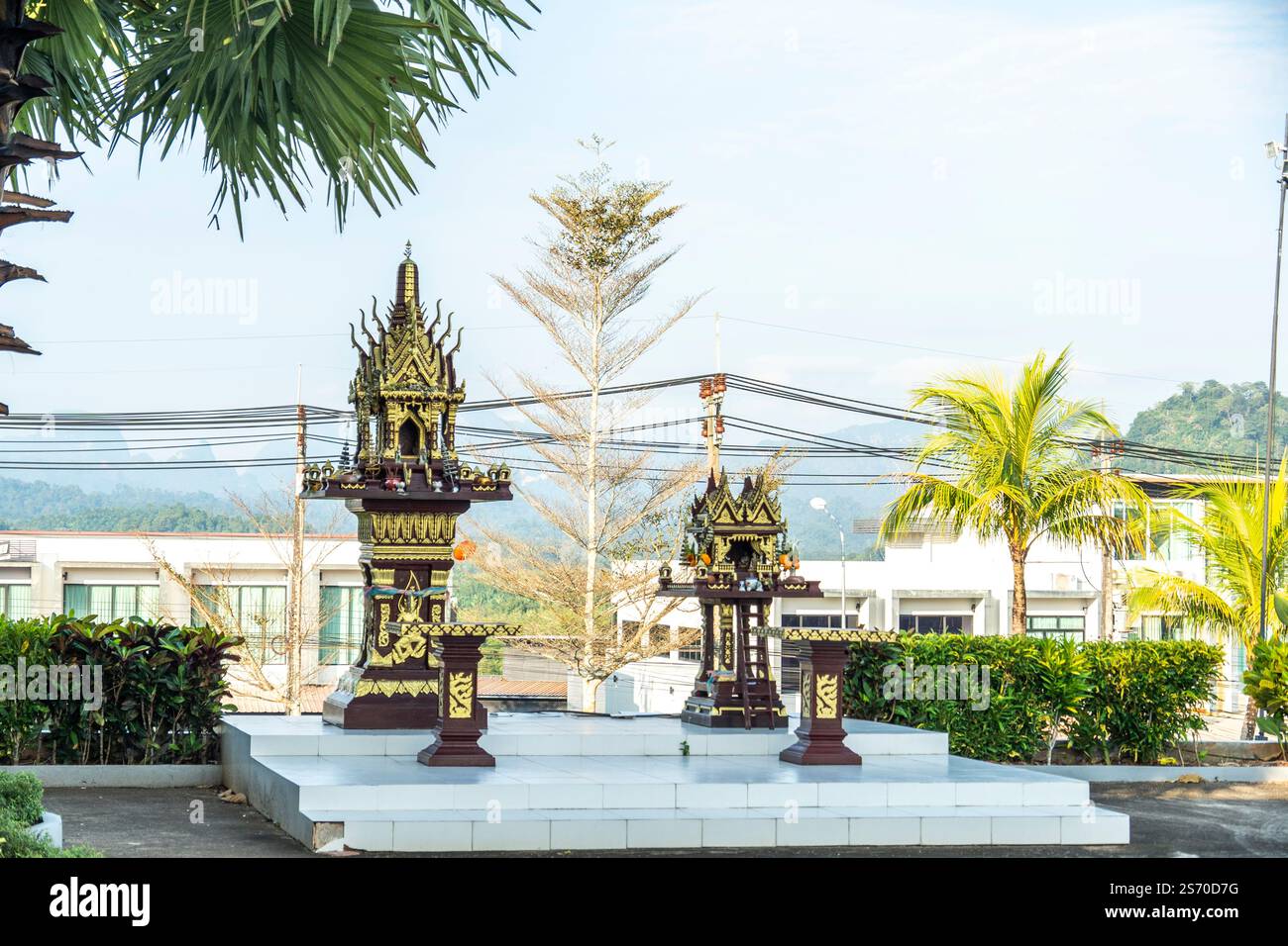 Traditional Balinese shrines located in a serene garden setting during daylight hours Stock ...