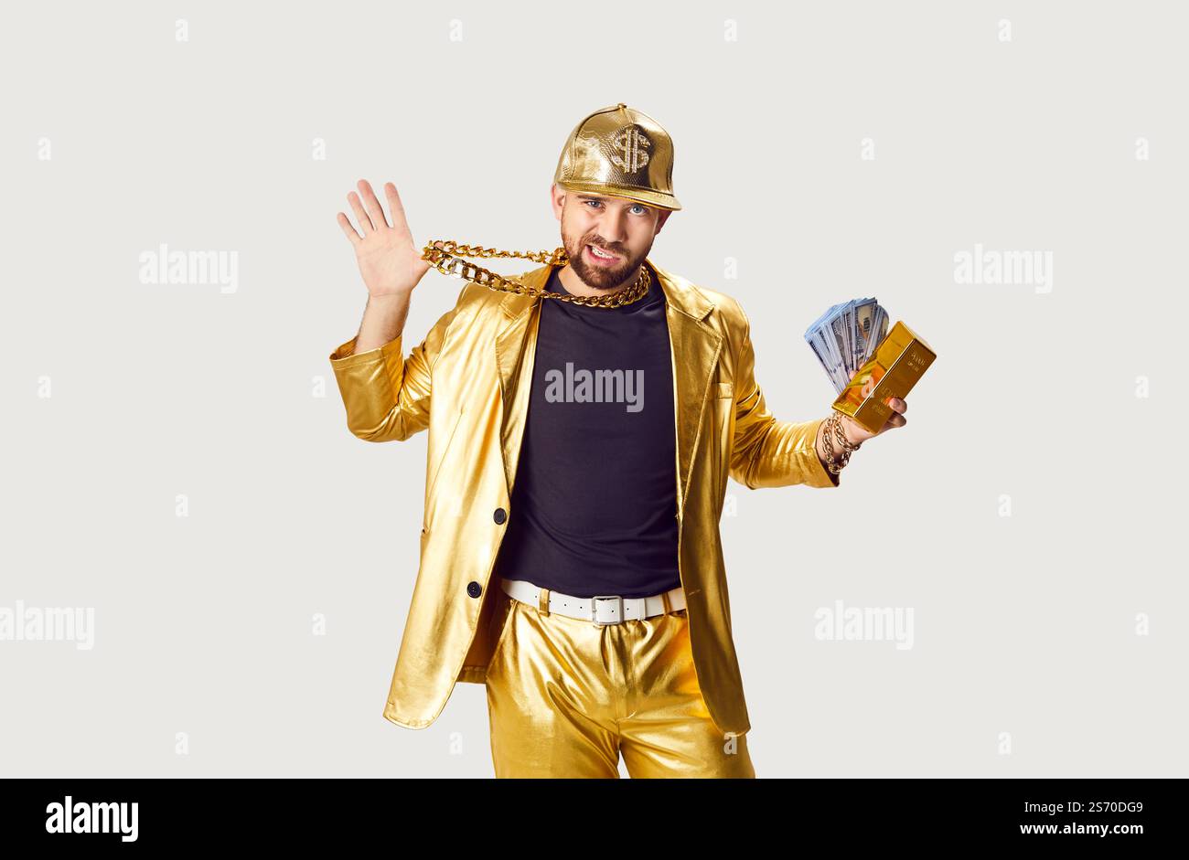 Wealthy Man In Gold Suit Holding Cash And Gold Bar Stock Photo - Alamy