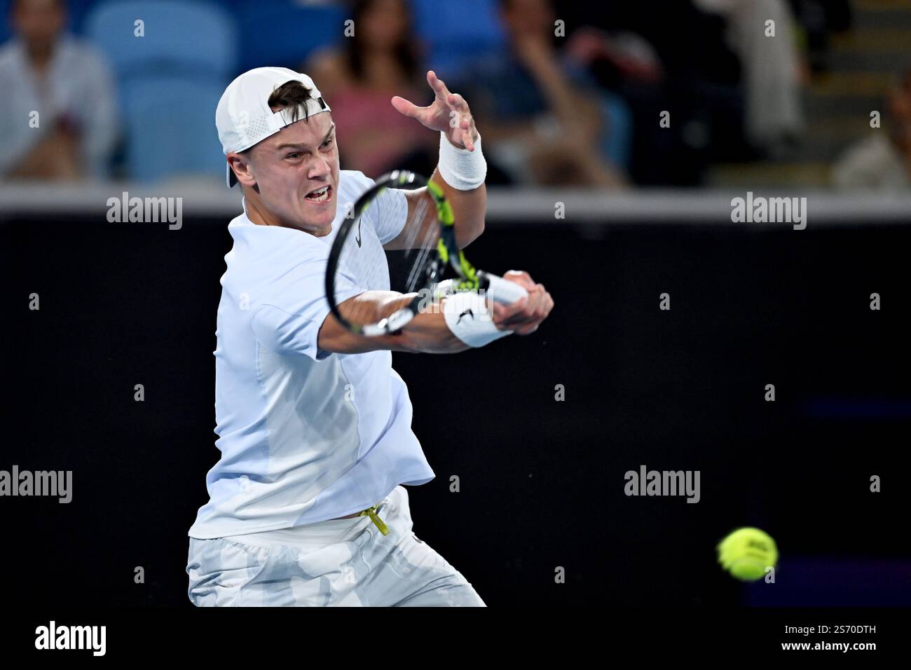 Melbourne, Australia. 18th Jan, 2025. Holger Rune of Denmark returns during his round three ...