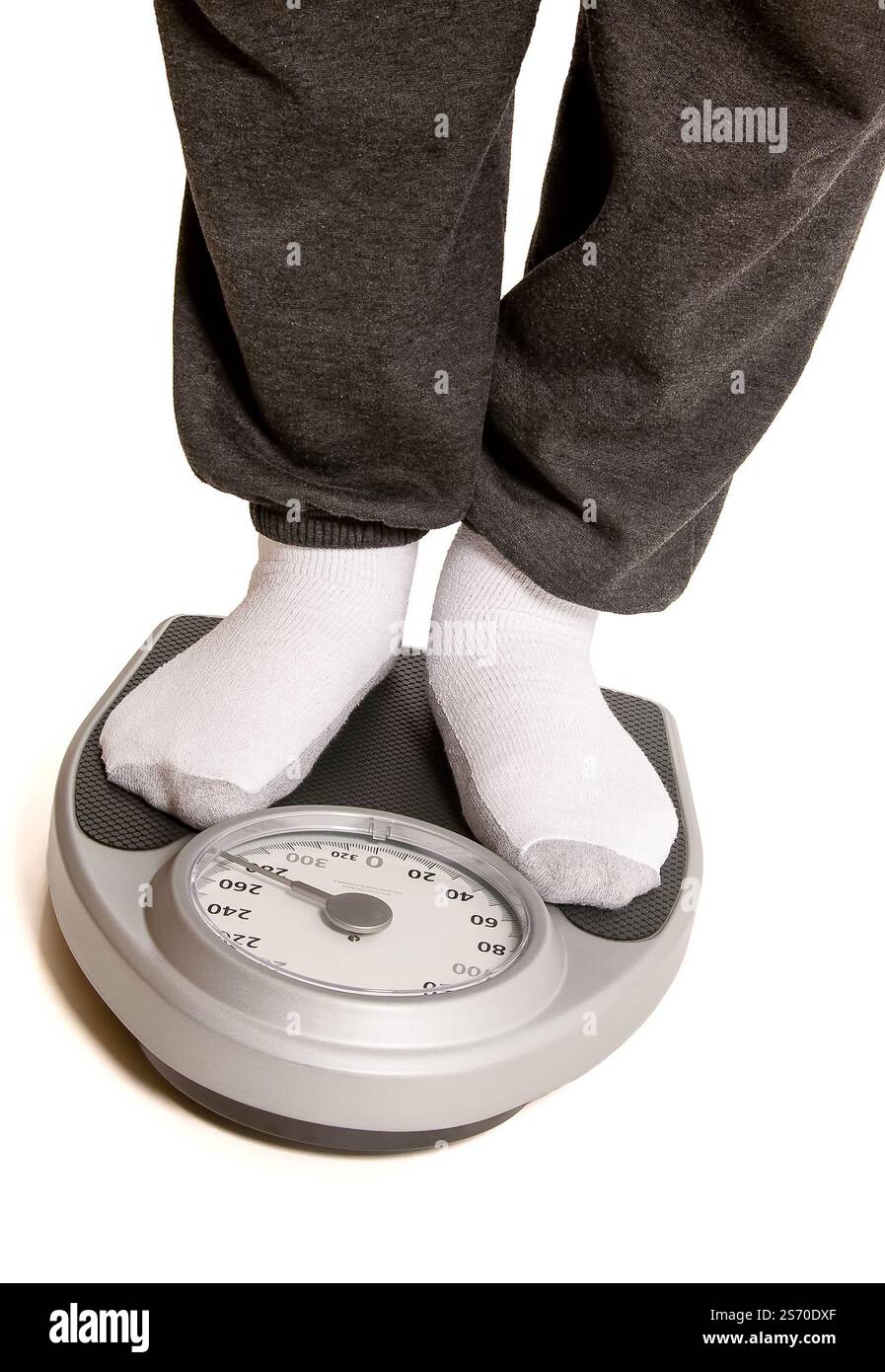 Close-up of feet in socks on a weight scale, symbolizing health and ...