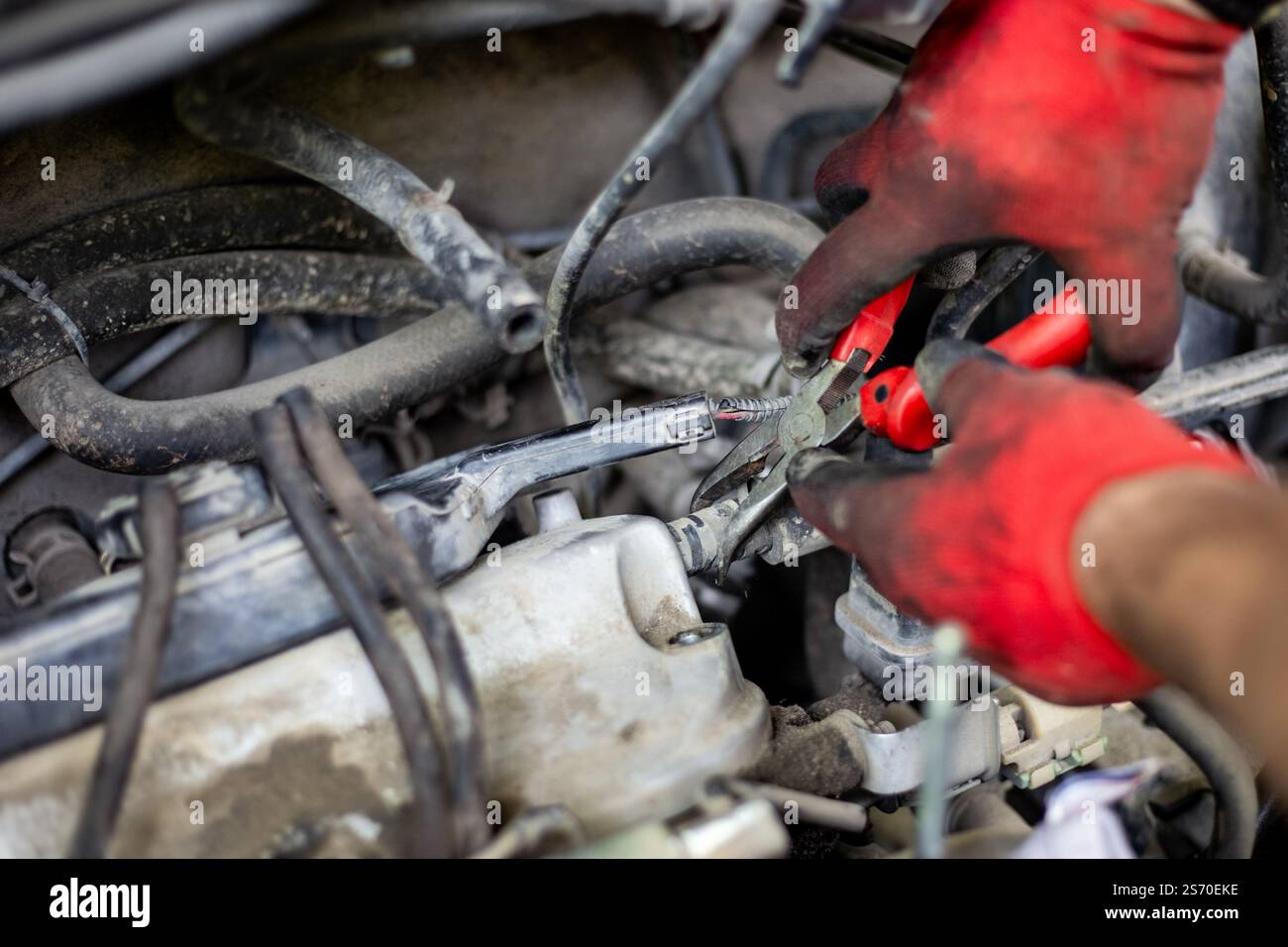 Car repair. Mechanic removes the engine crankcase gas recirculation ...