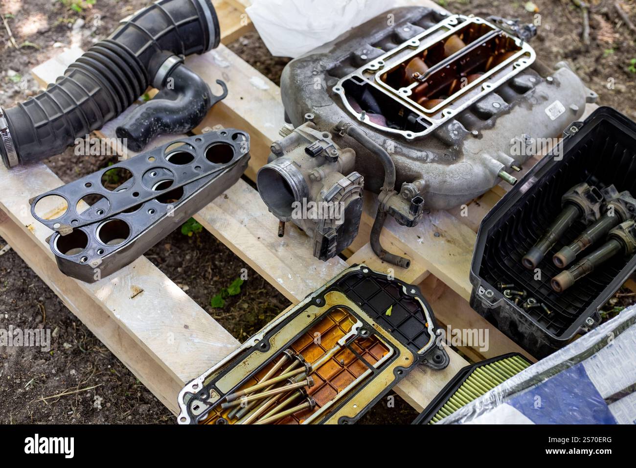 Car repair. Car intake manifold parts in disassembly Stock Photo - Alamy