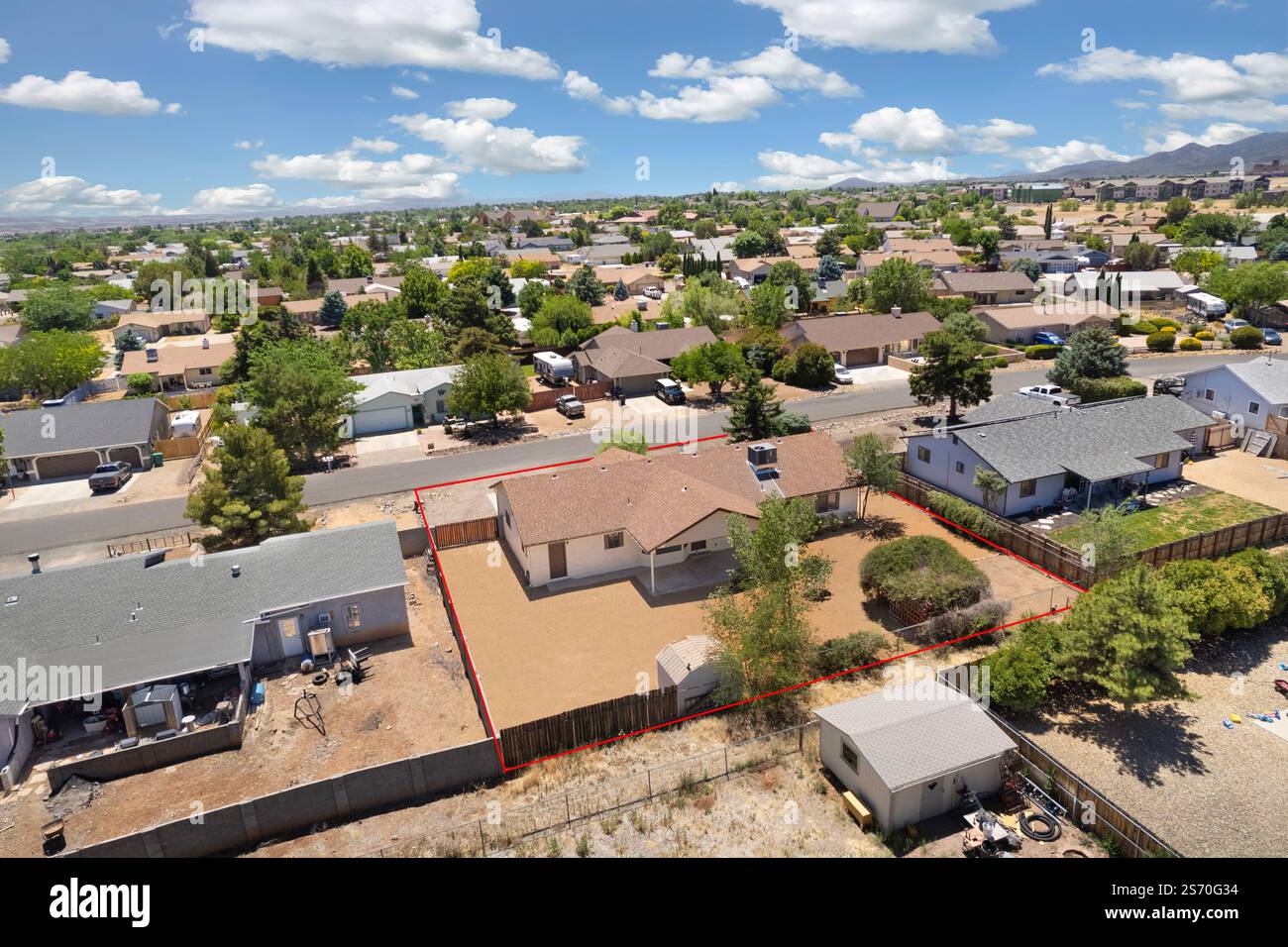 A wide-angle view reveals a quiet residential neighborhood with several ...