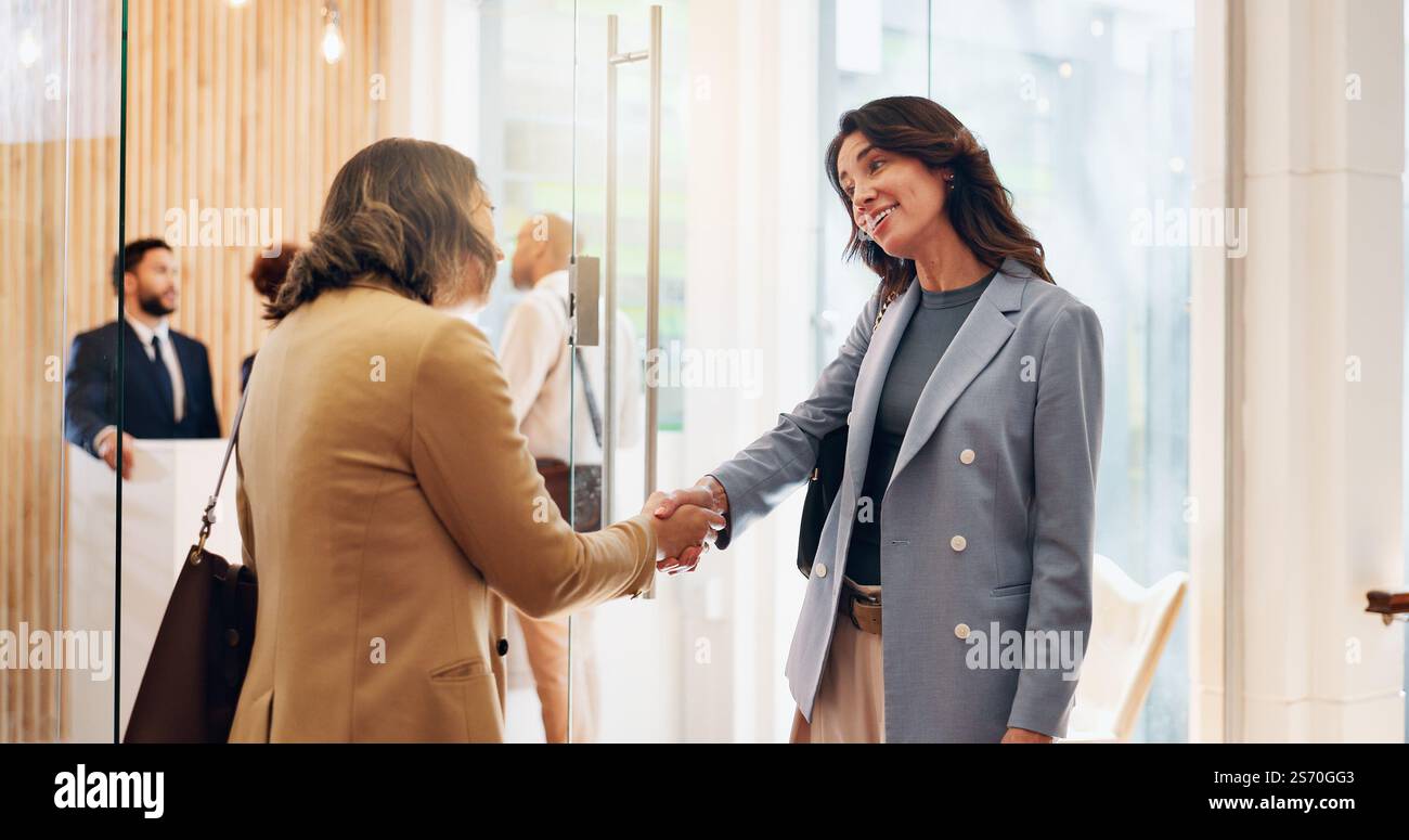 Handshake, smile and welcome with business women in lobby of office for ...