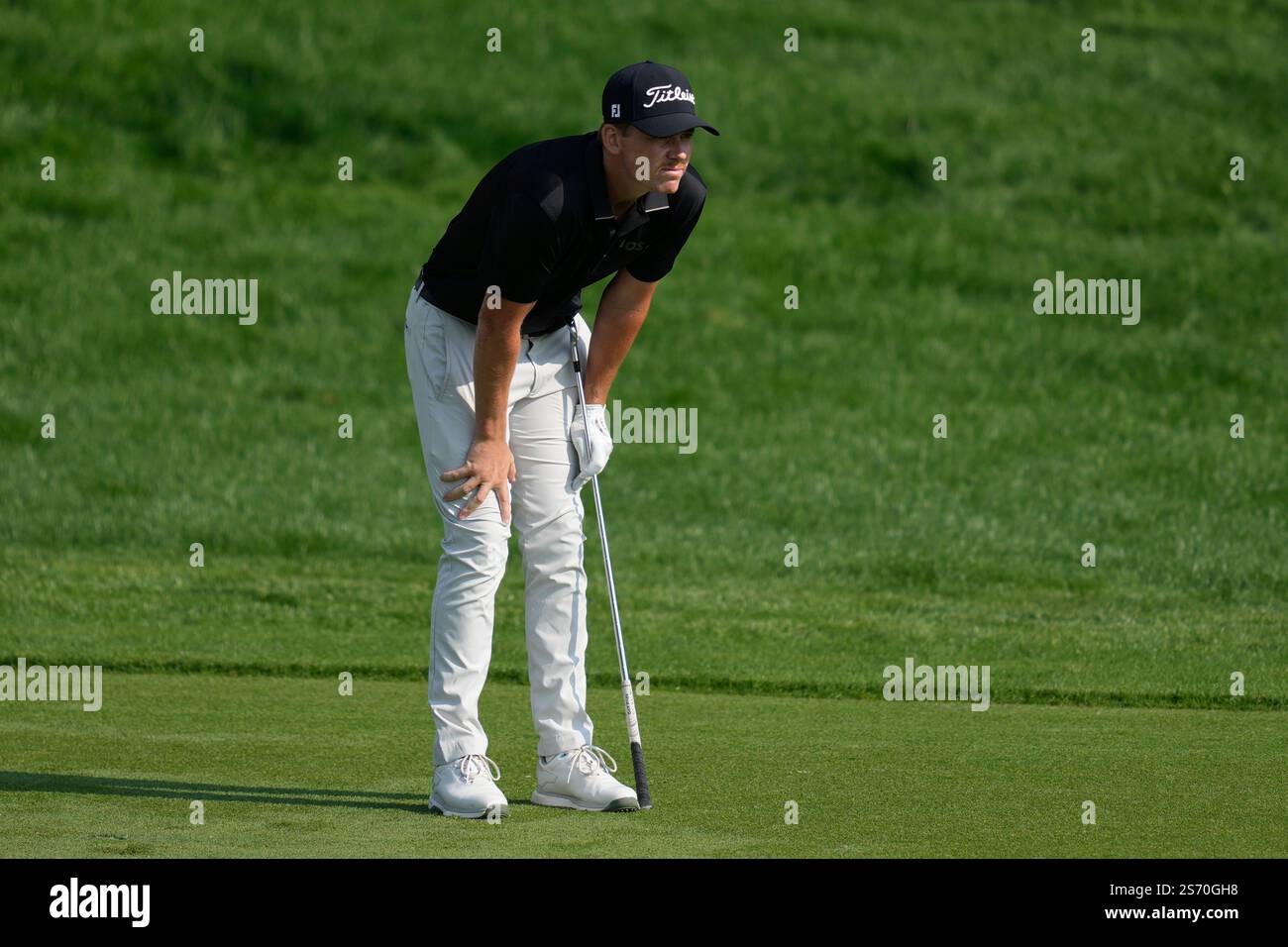 Daniel Hillier of New Zealand watches his shot from the 9th fairway ...