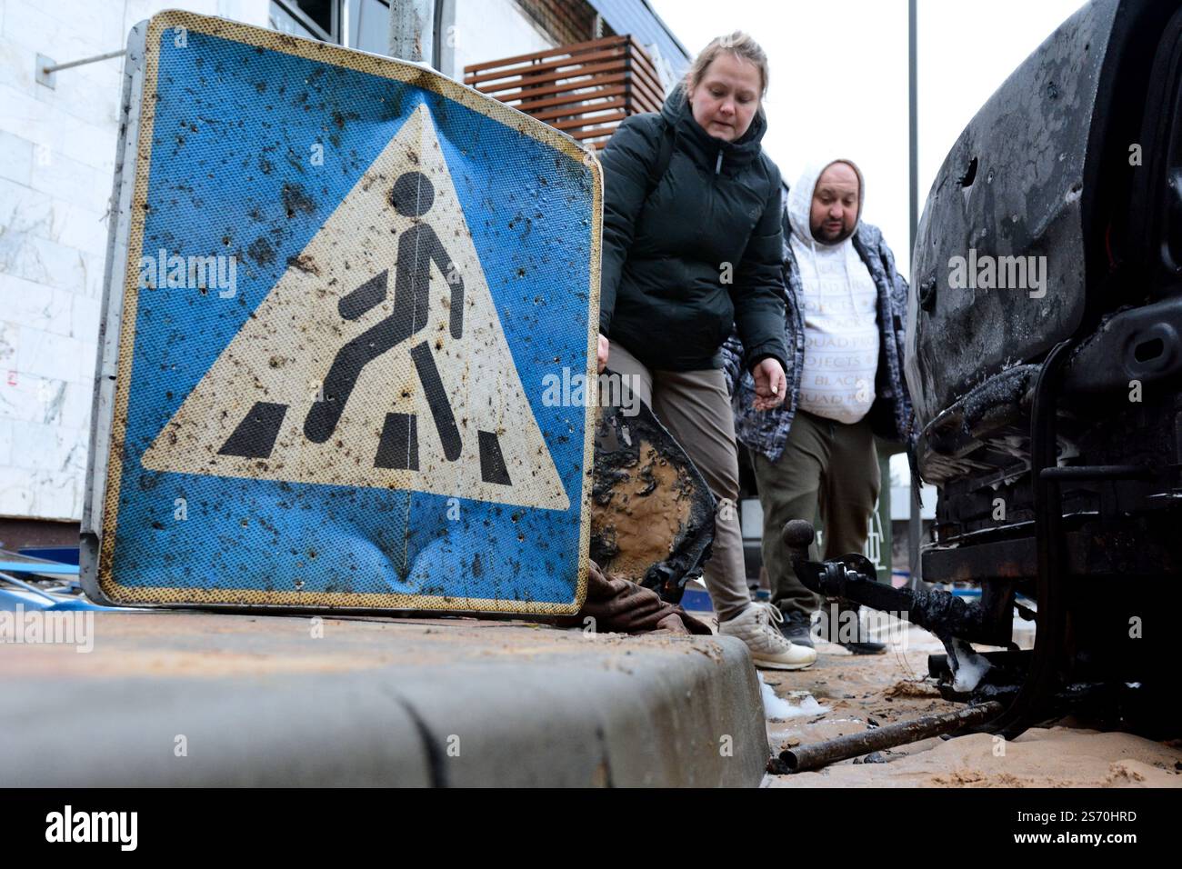 A couple inspects their car after a rocket attack in Kyiv. (Photo by Aleksandr Gusev / SOPA ...