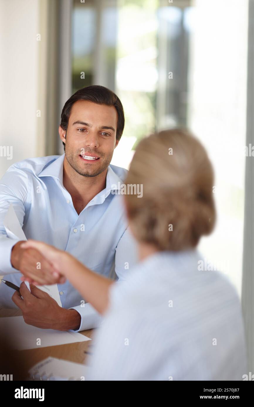 Man, woman and handshake at interview with documents, assessment and ...
