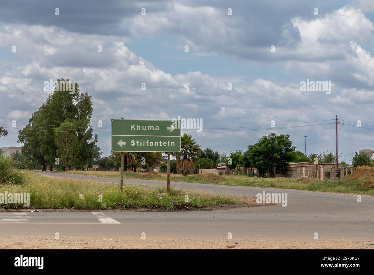 Wide shot of road sign reading Khuma and Stilfontein in left and right ...