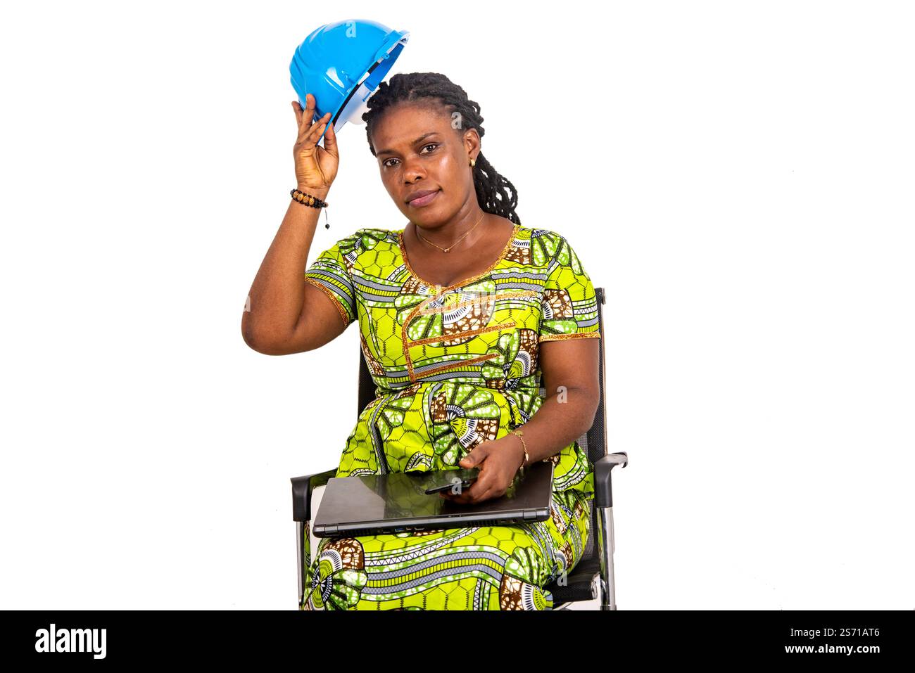 beautiful young female engineer wearing safety helmet sitting on chair ...