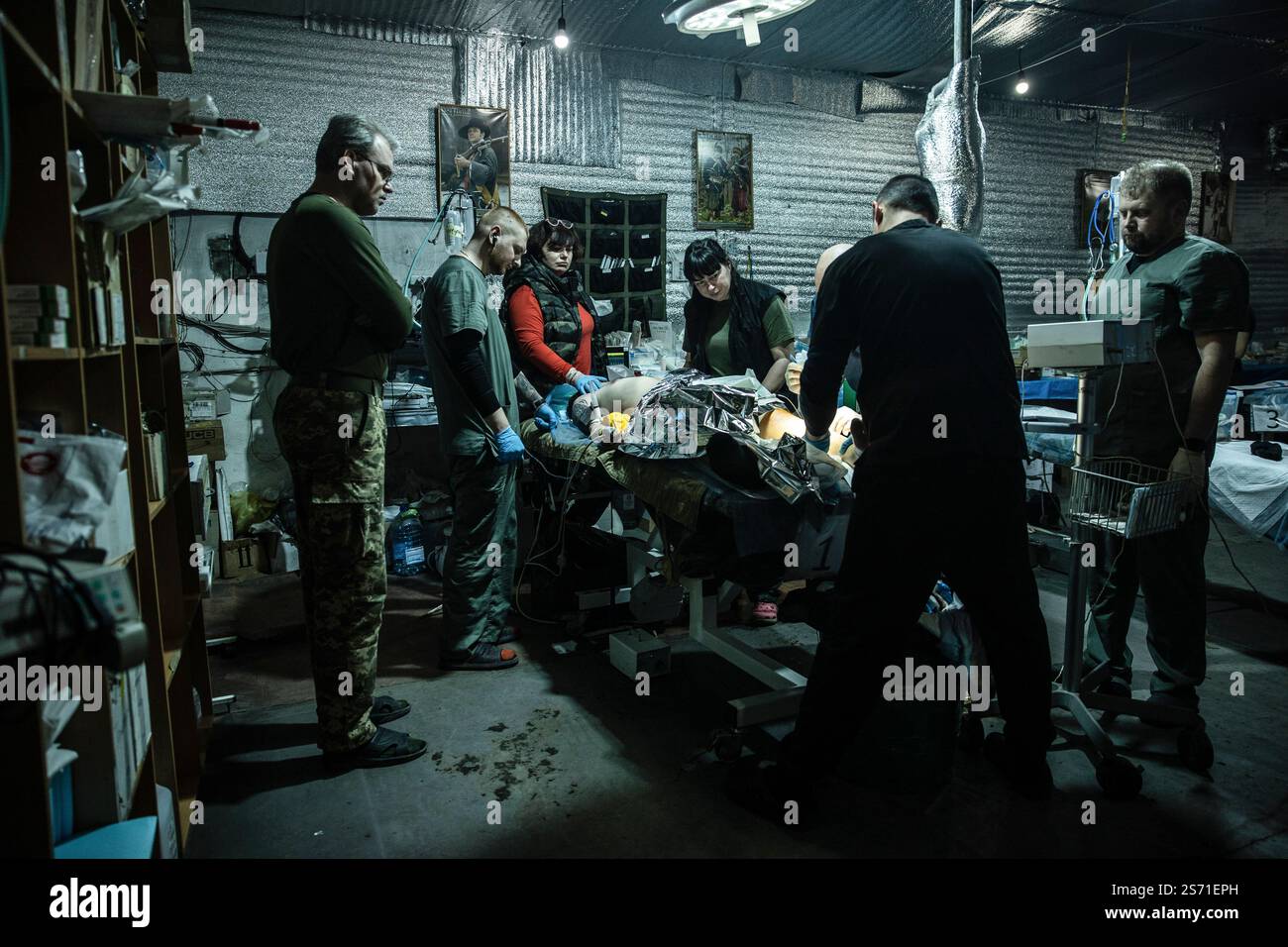 Military medics give first aid to a wounded Ukrainian soldier at a ...
