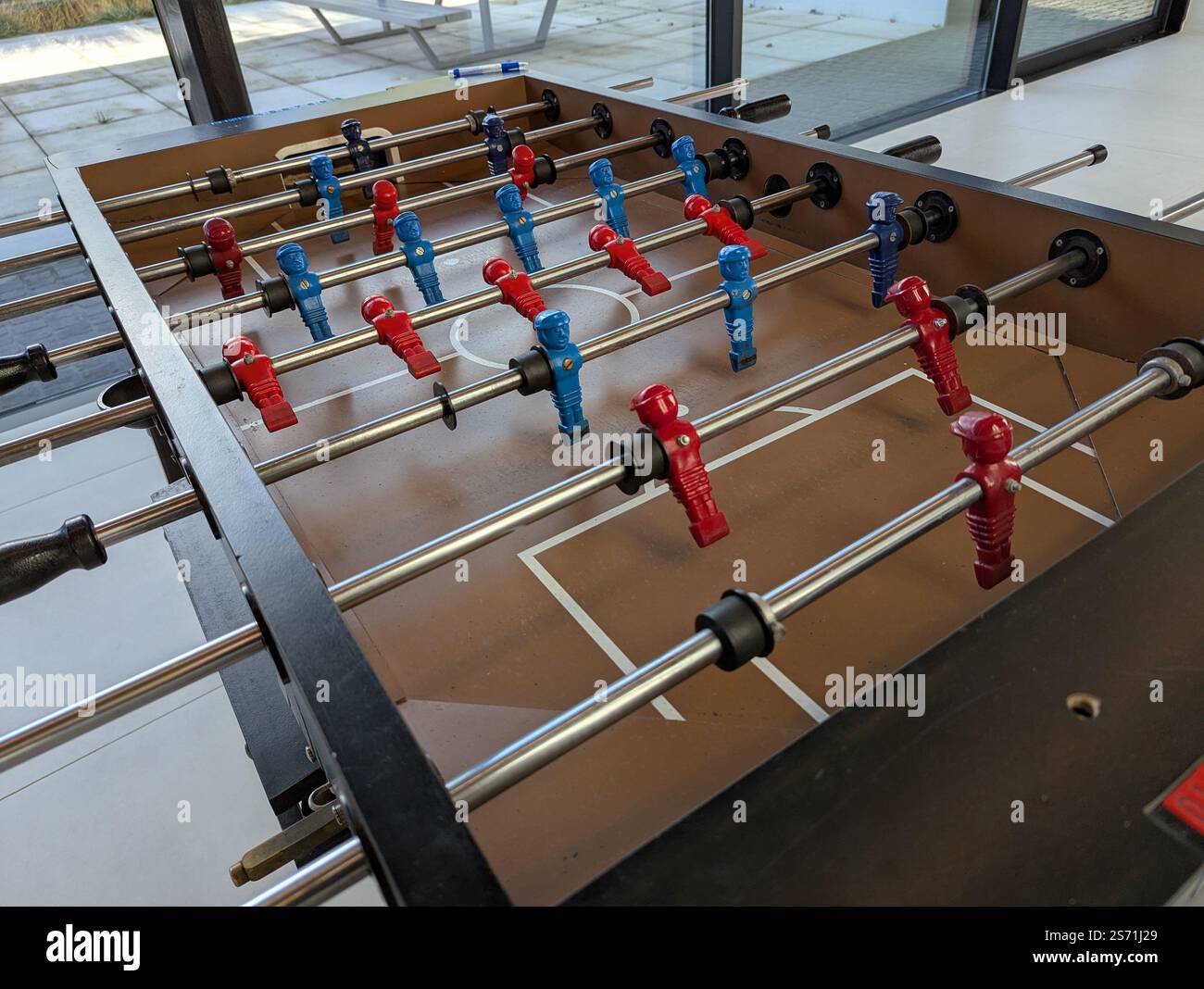 A top down portrait of a foosball table in a bar or café, all the ...