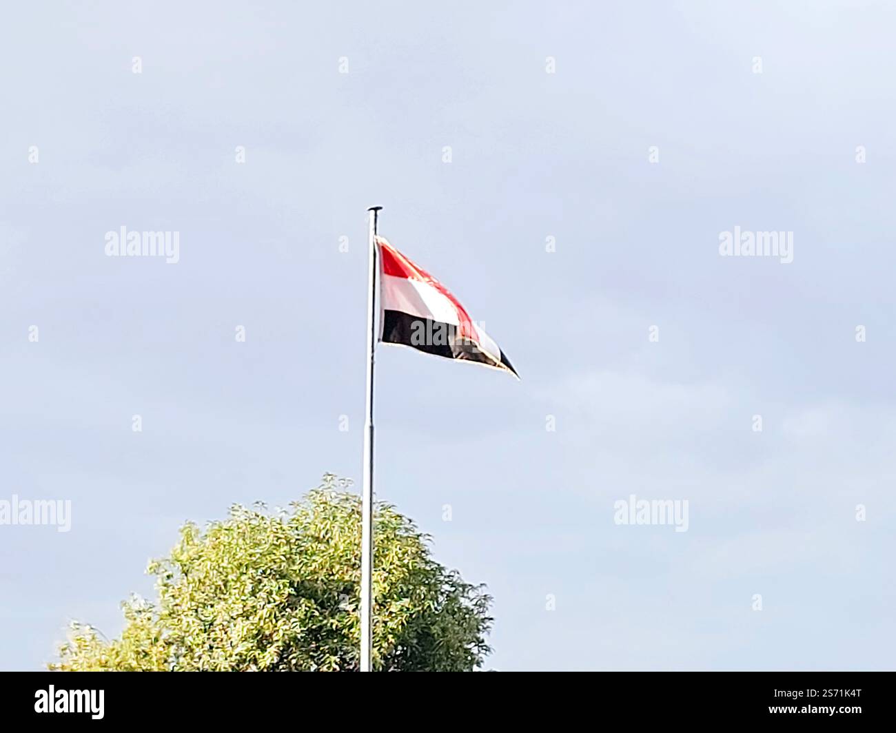 The national flag of Egypt, a tricolor consisting of the three equal ...