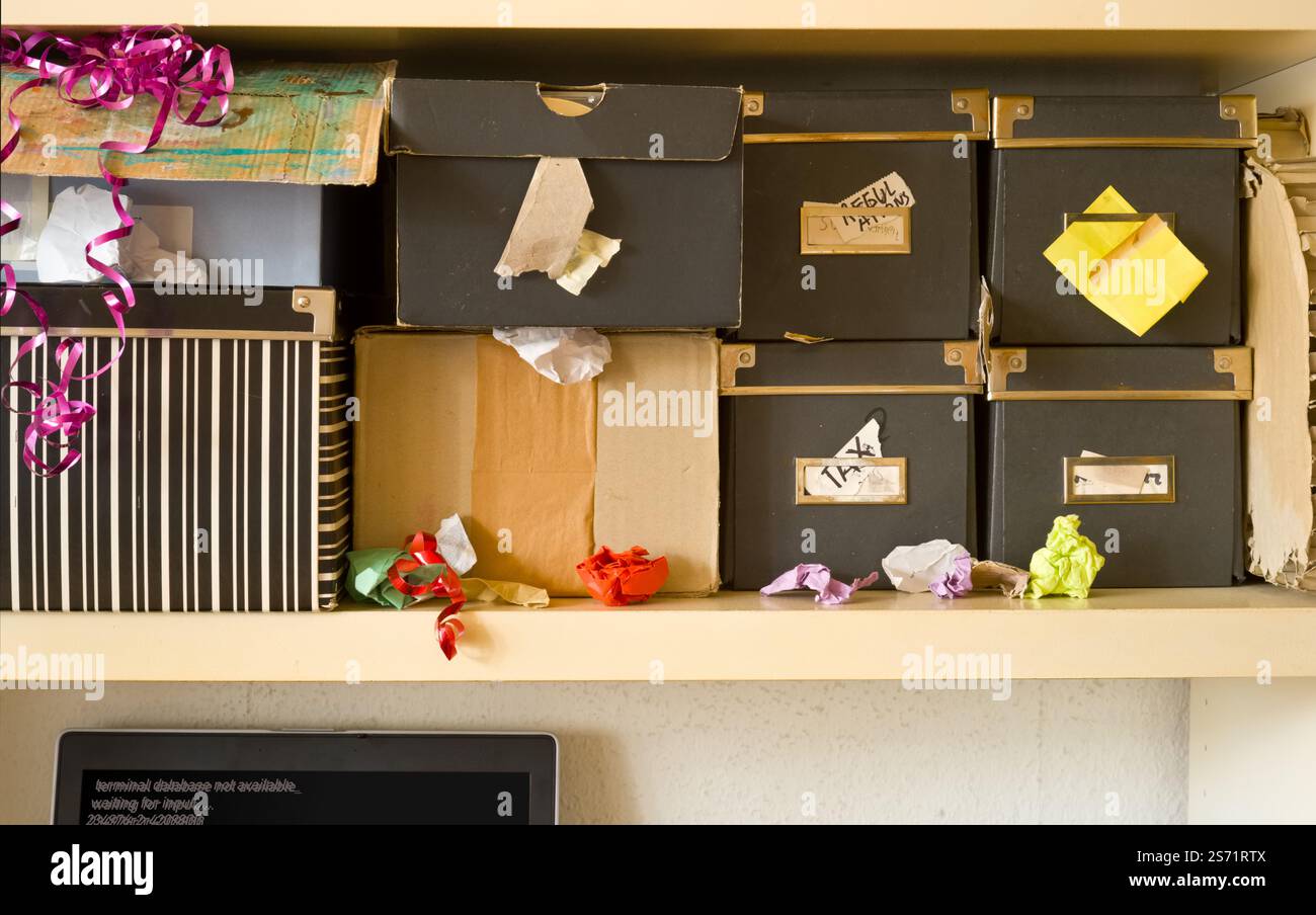 messy file folders and storage boxes in a cluttered office bookshelf ...