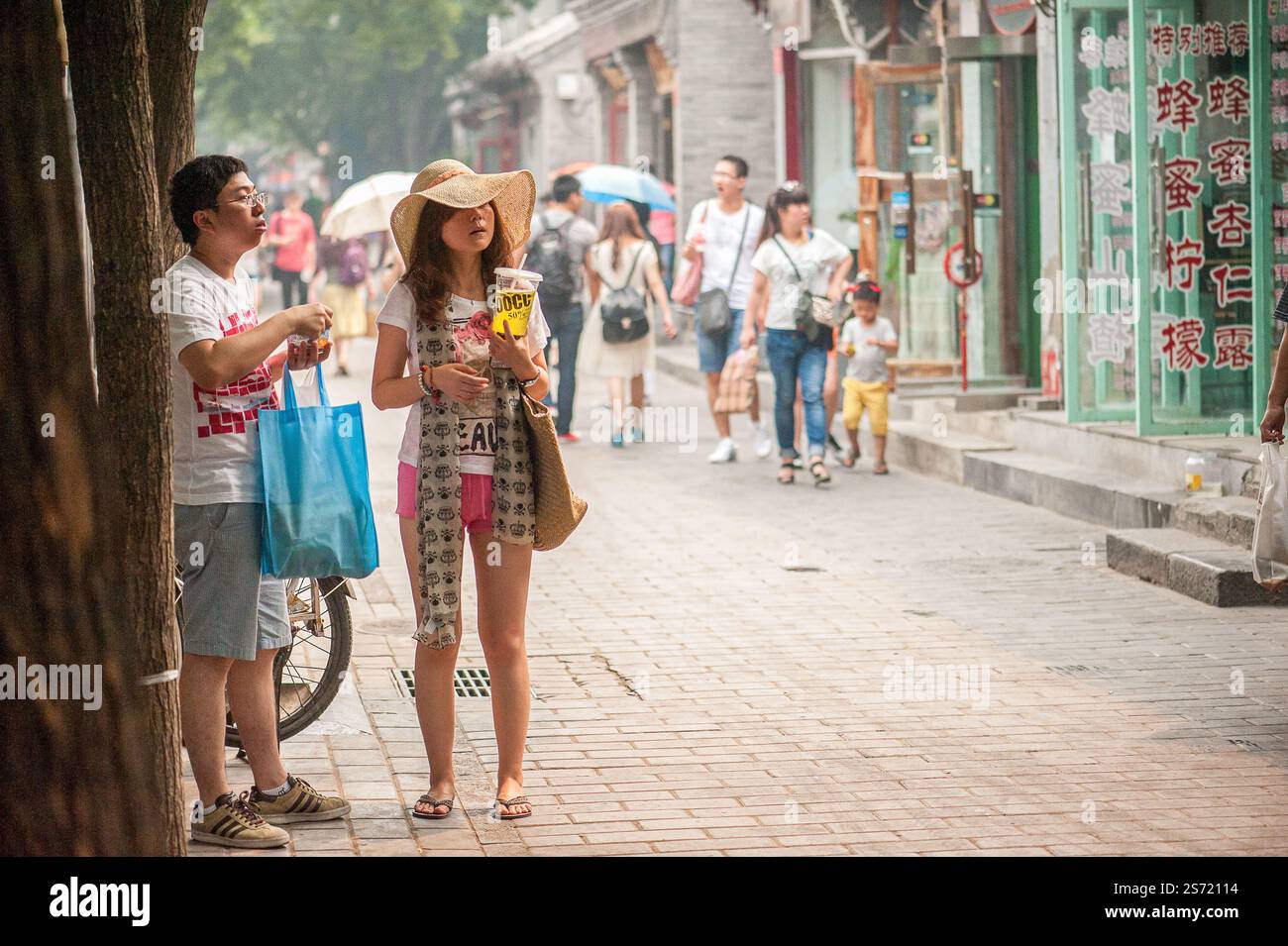 Tourists explore the Jing Yang Hutong of Beijing. The Hutongs provide a ...