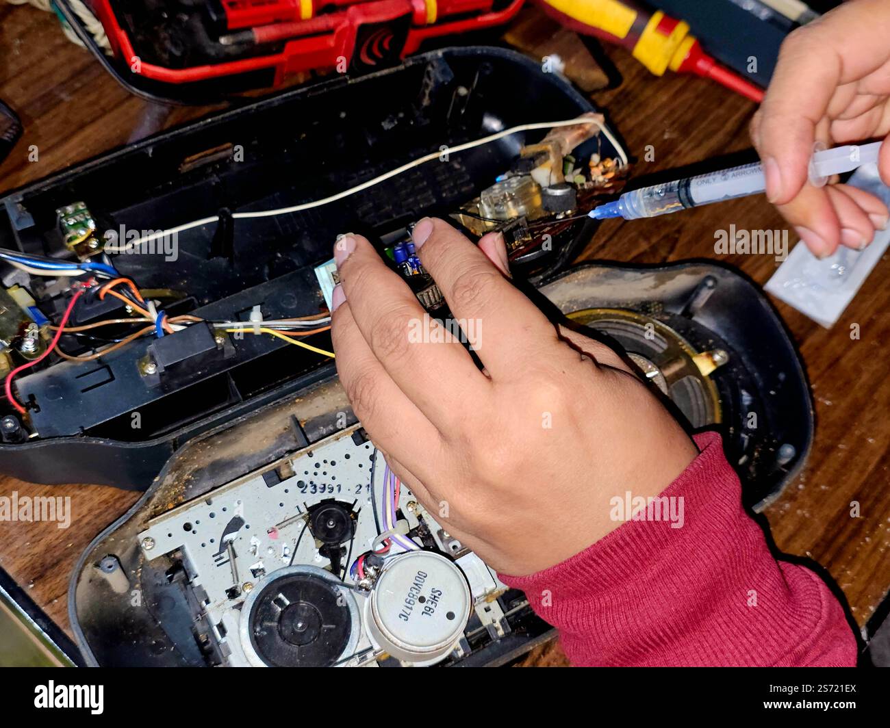 Cairo, Egypt, December 25 2024: An old radio cassette player maintenance, using standard old ...