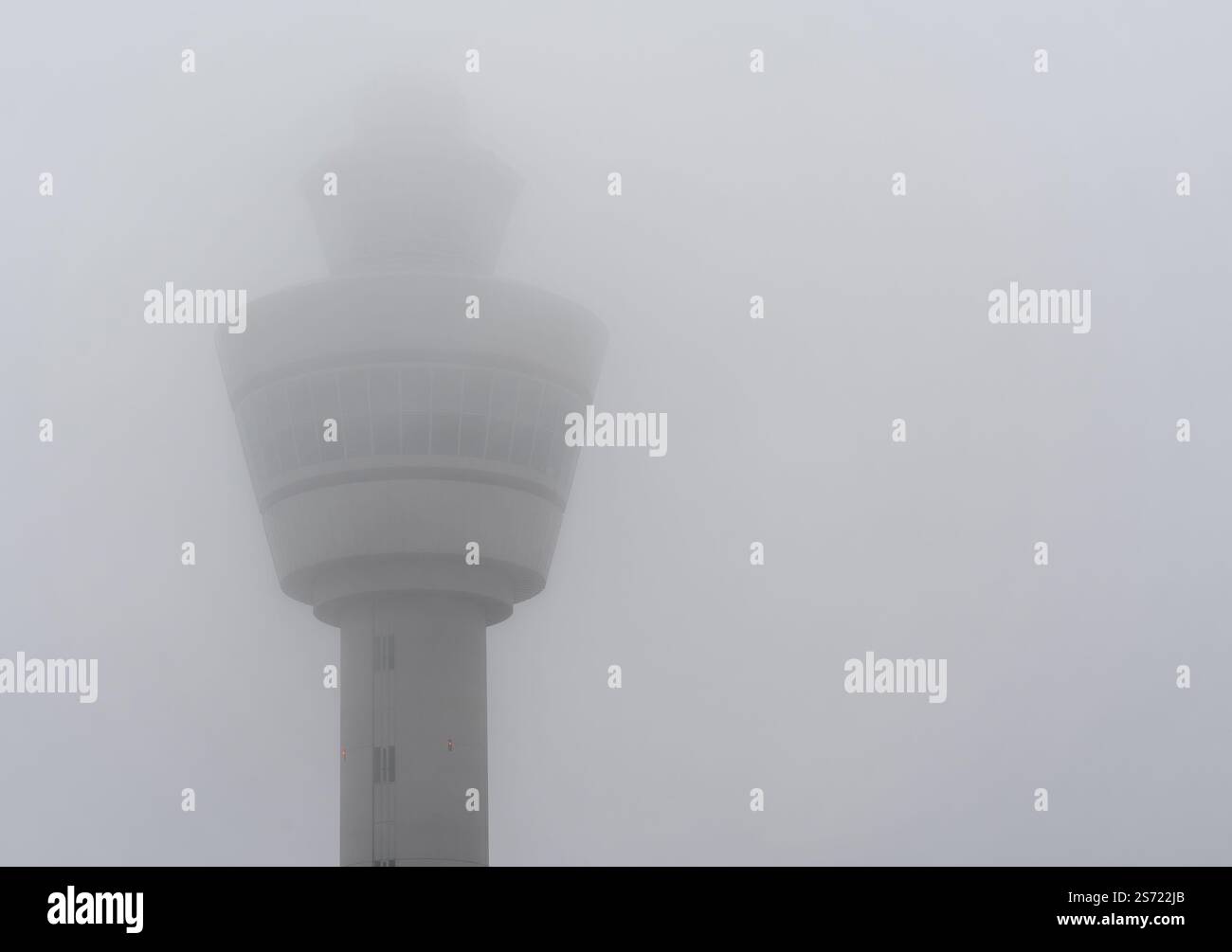 Air traffic control tower at the Airport in thick mist, low visibility ...