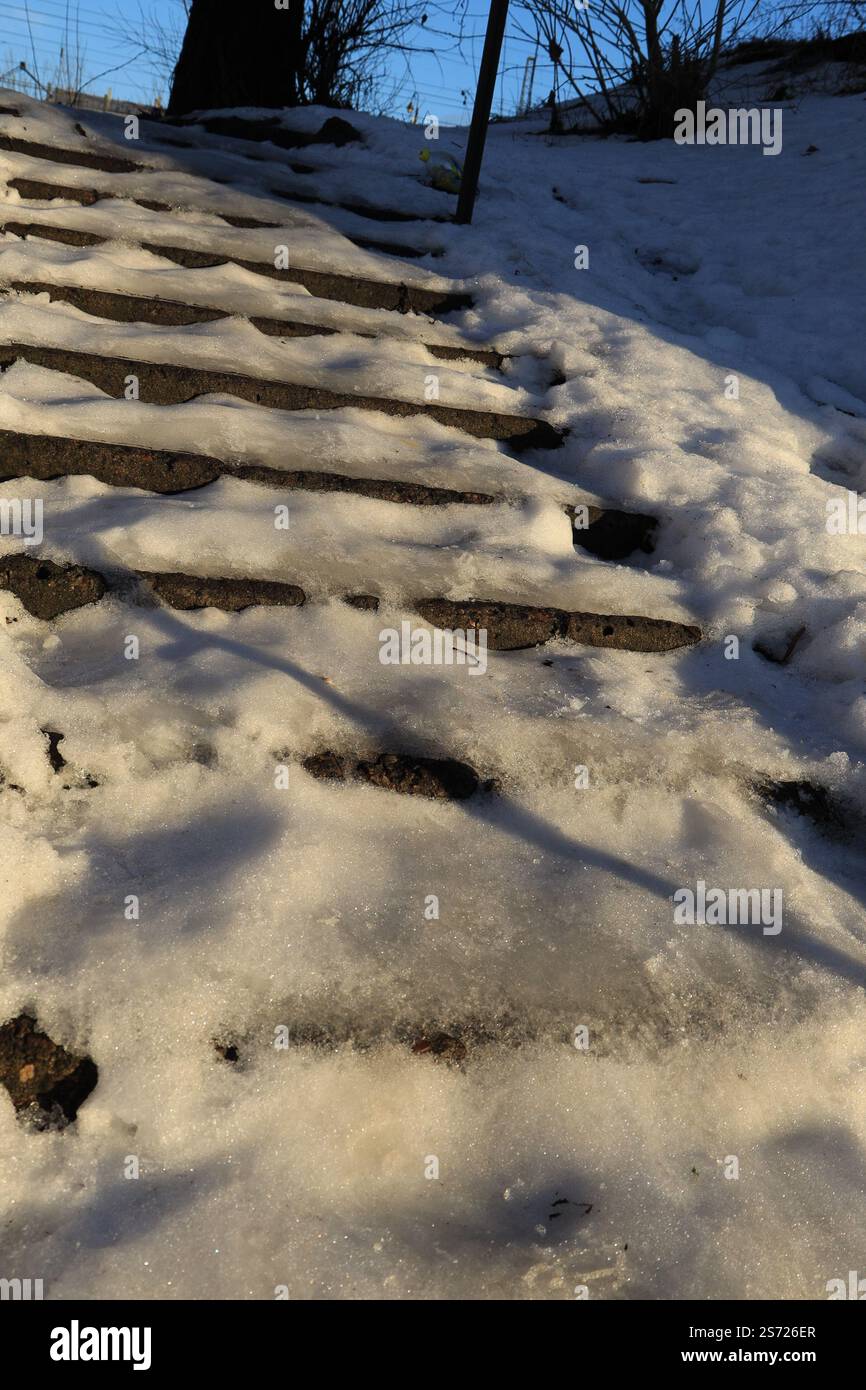 Dangerous steps of uncleared street stairs heavily covered with ice and ...