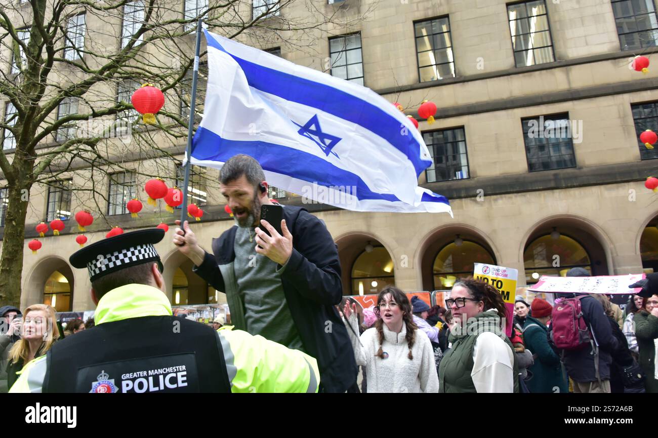 A lone man holding an Israeli flag in St Peter's Square, Manchester ...