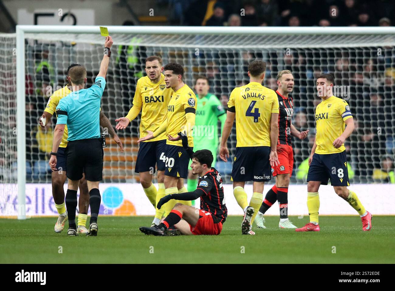 Oxford United's Michal Helik (second left) receives a yellow card from ...