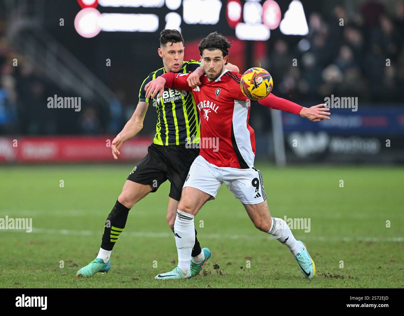 Salford City's Cole Stockton holds off Fleetwood Town's James Bolton as ...