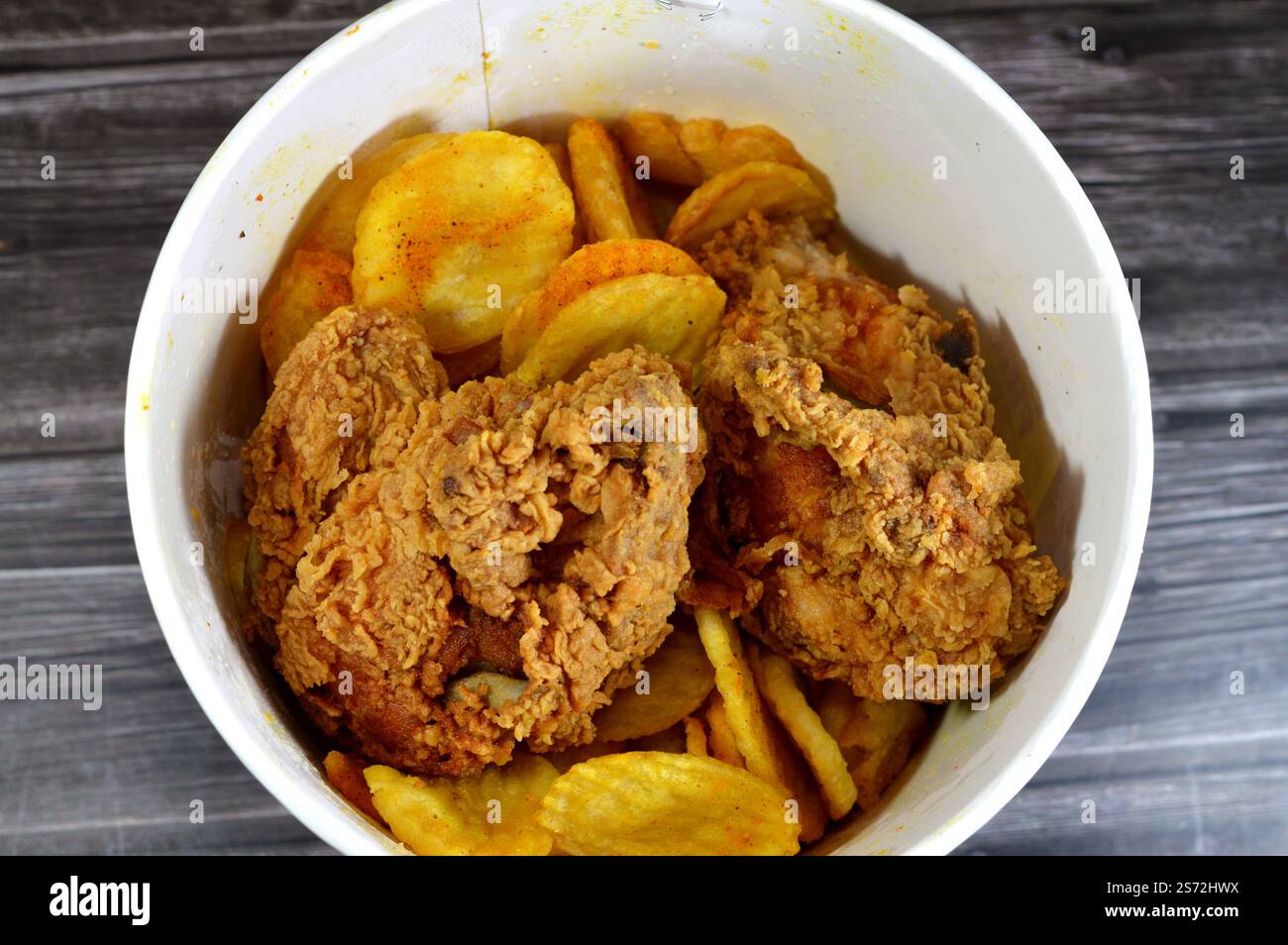 Broasted chicken meal with fried potato chips, a broast chicken pieces ...