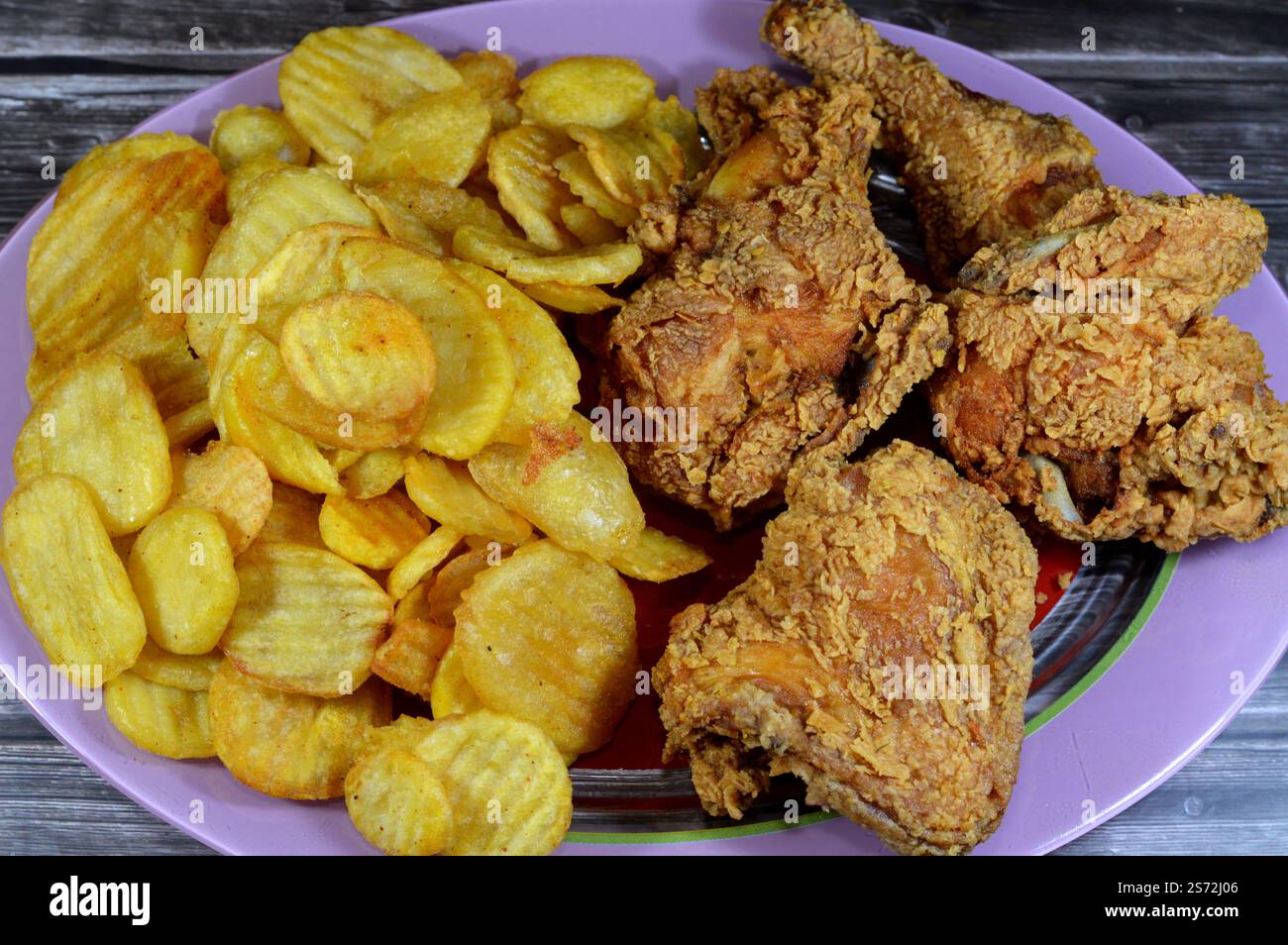 Broasted chicken meal with fried potato chips, a broast chicken pieces ...