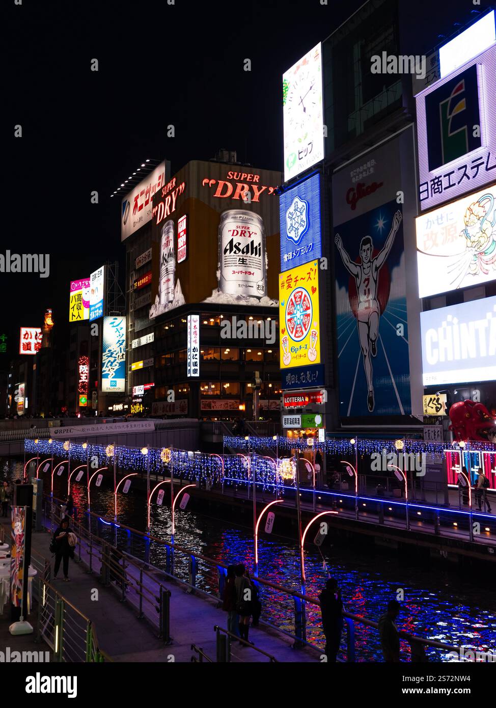 A vibrant night scene in Osaka's Dotonbori district, illuminated by ...