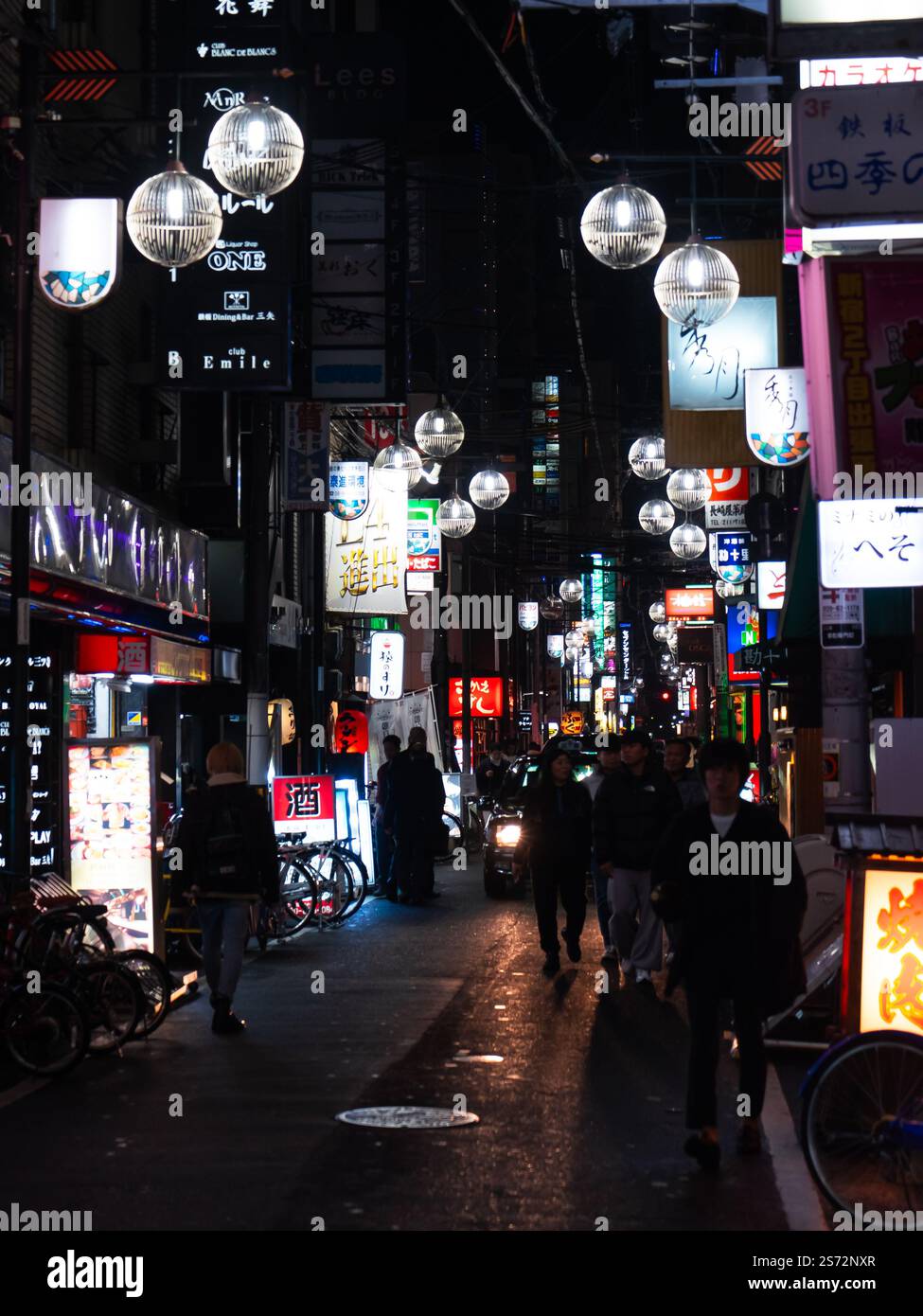 A vibrant night scene in Osaka's Dotonbori district, illuminated by ...