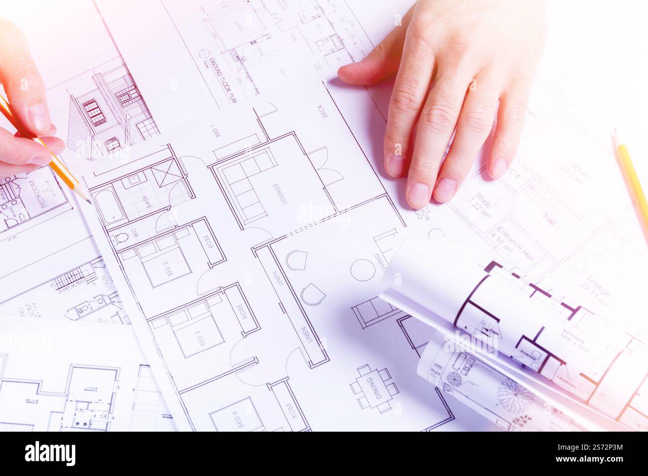 Builder's hands on the background of a house plan. Construction ...